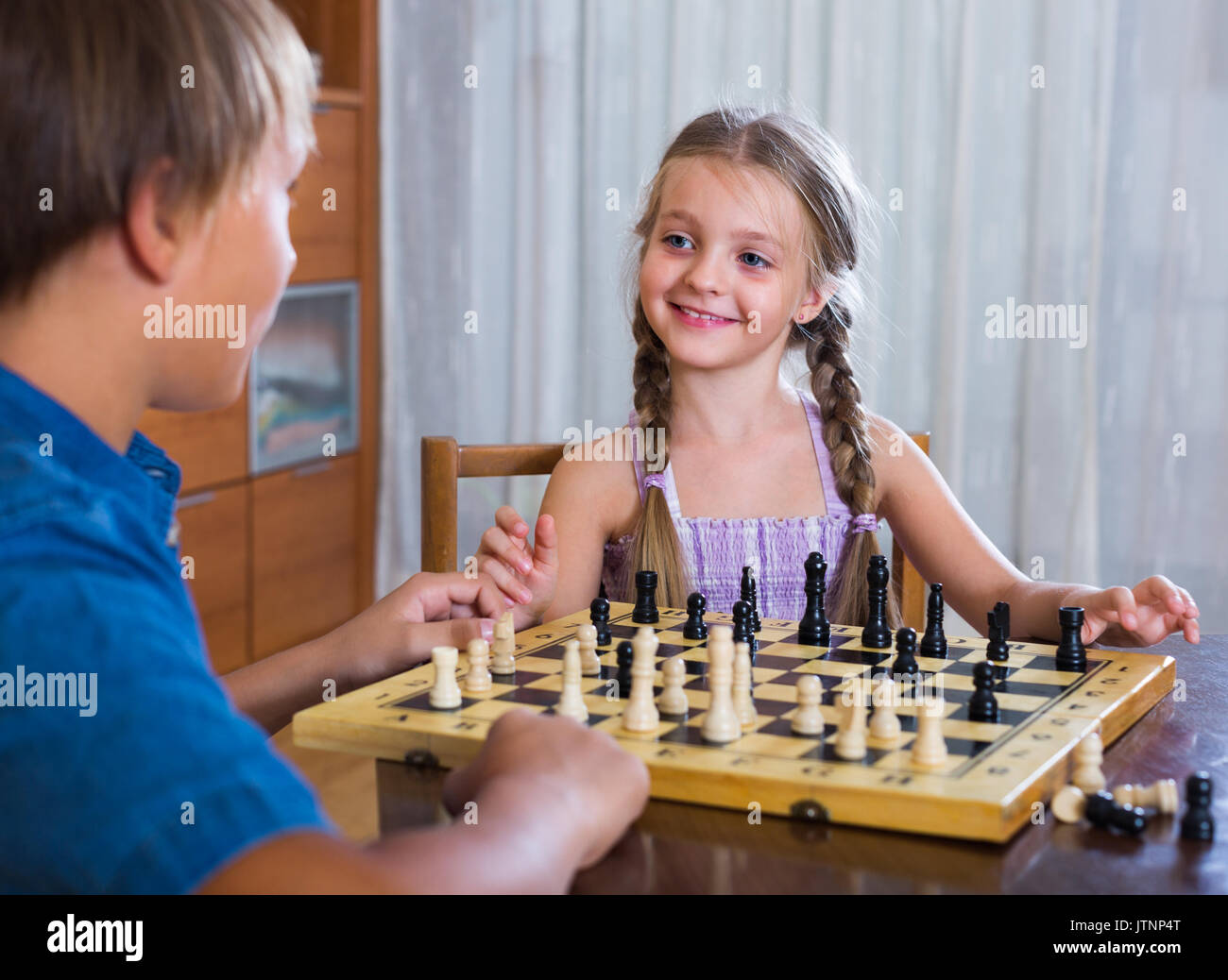 Portrait of happy children at chess board in domestic interior Stock ...