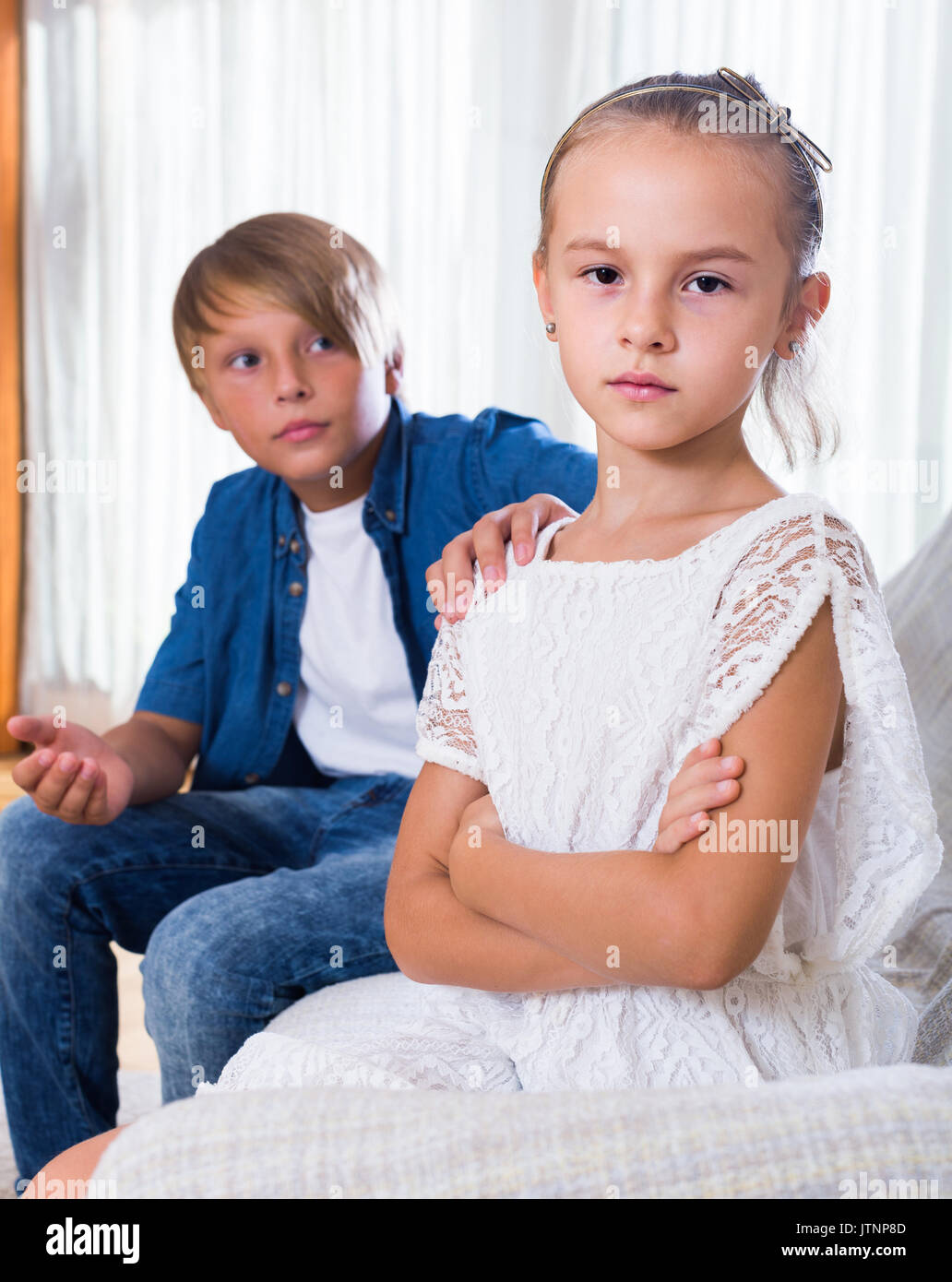 Quarrel between brother and small russian sister in domestic interior ...