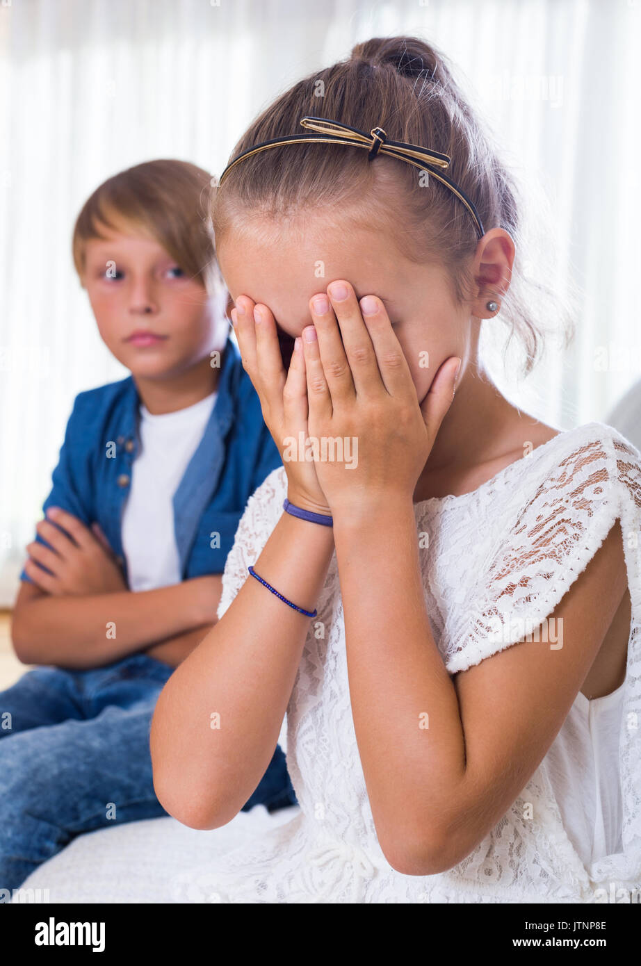 Quarrel between american brother and small sister in domestic interior ...