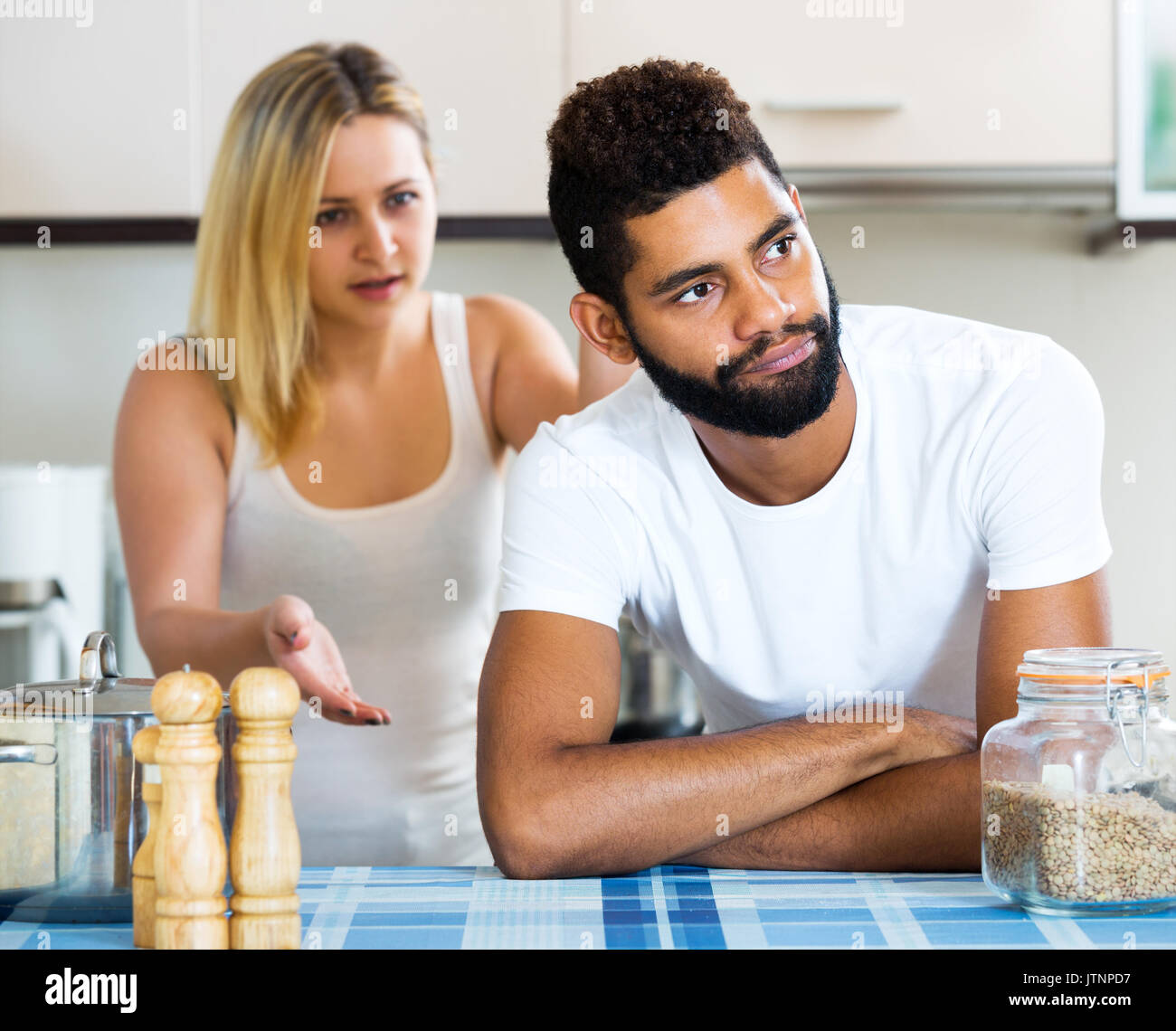 Sad young man and white crying woman fighting in domestic kitchen ...