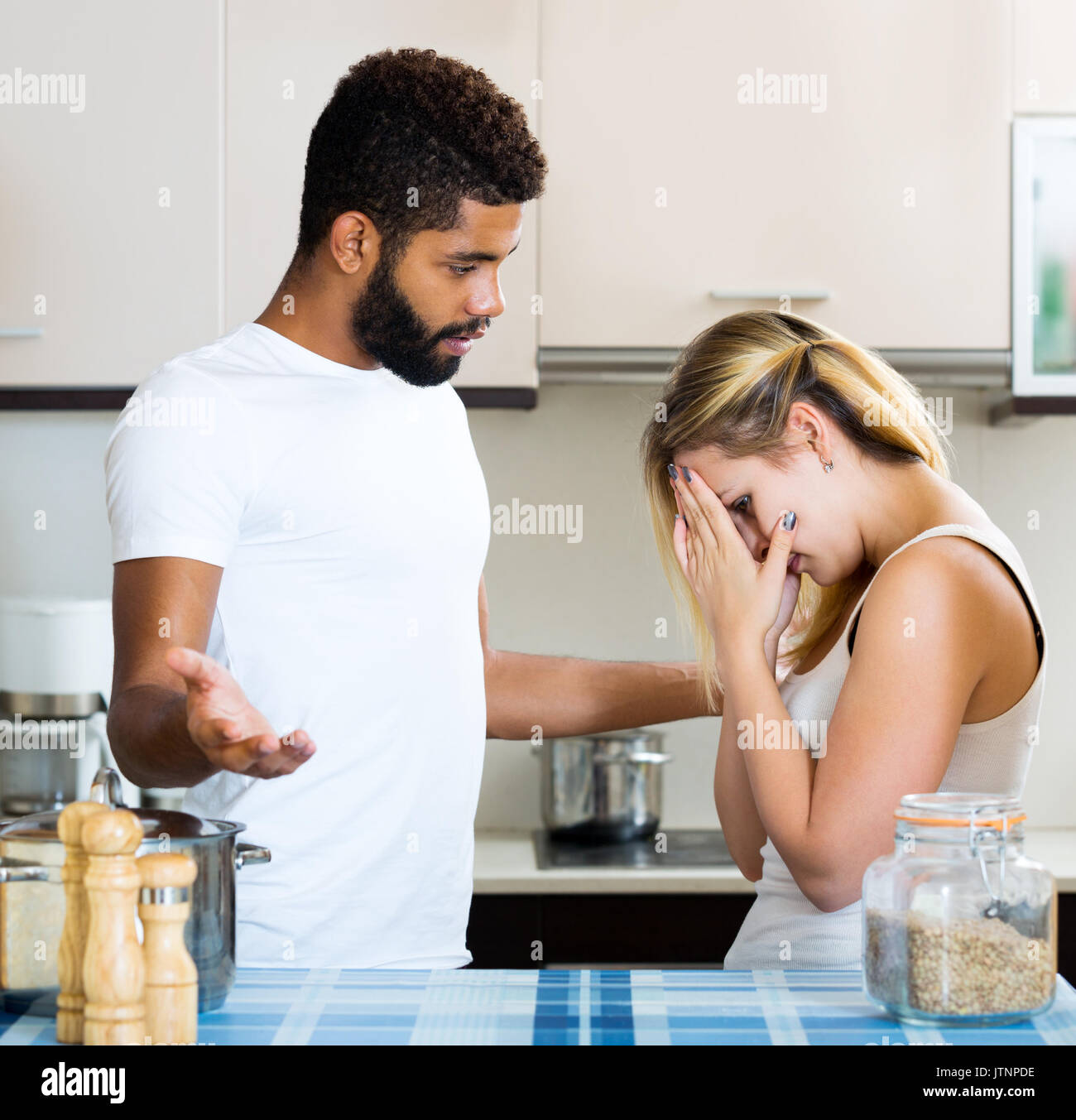 Sad young guy and white crying girl fighting in domestic kitchen Stock ...