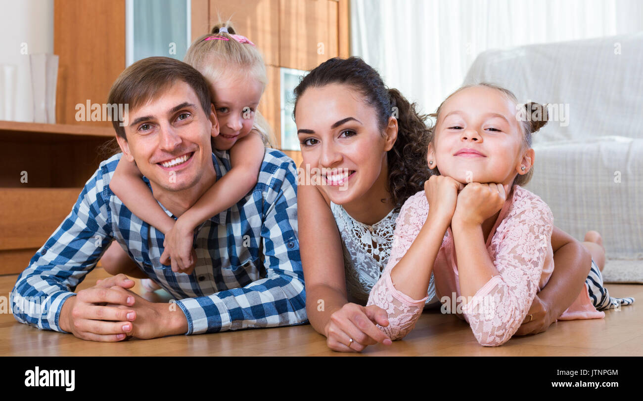 american family values: portrait of happy parents with little girls ...