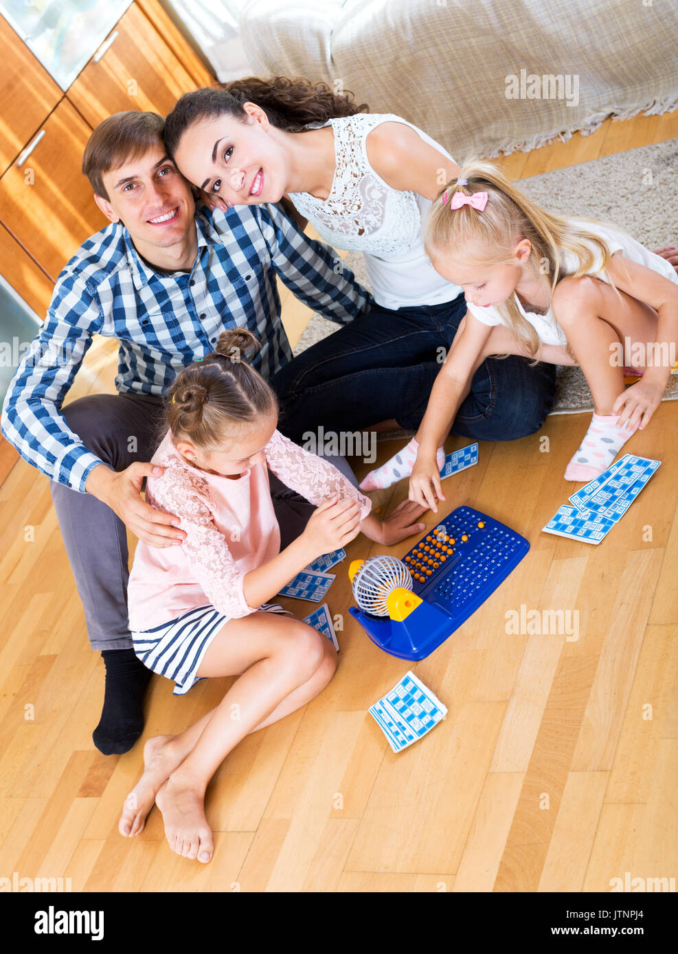 Little girls with parents trying chances at lotto game Stock Photo - Alamy