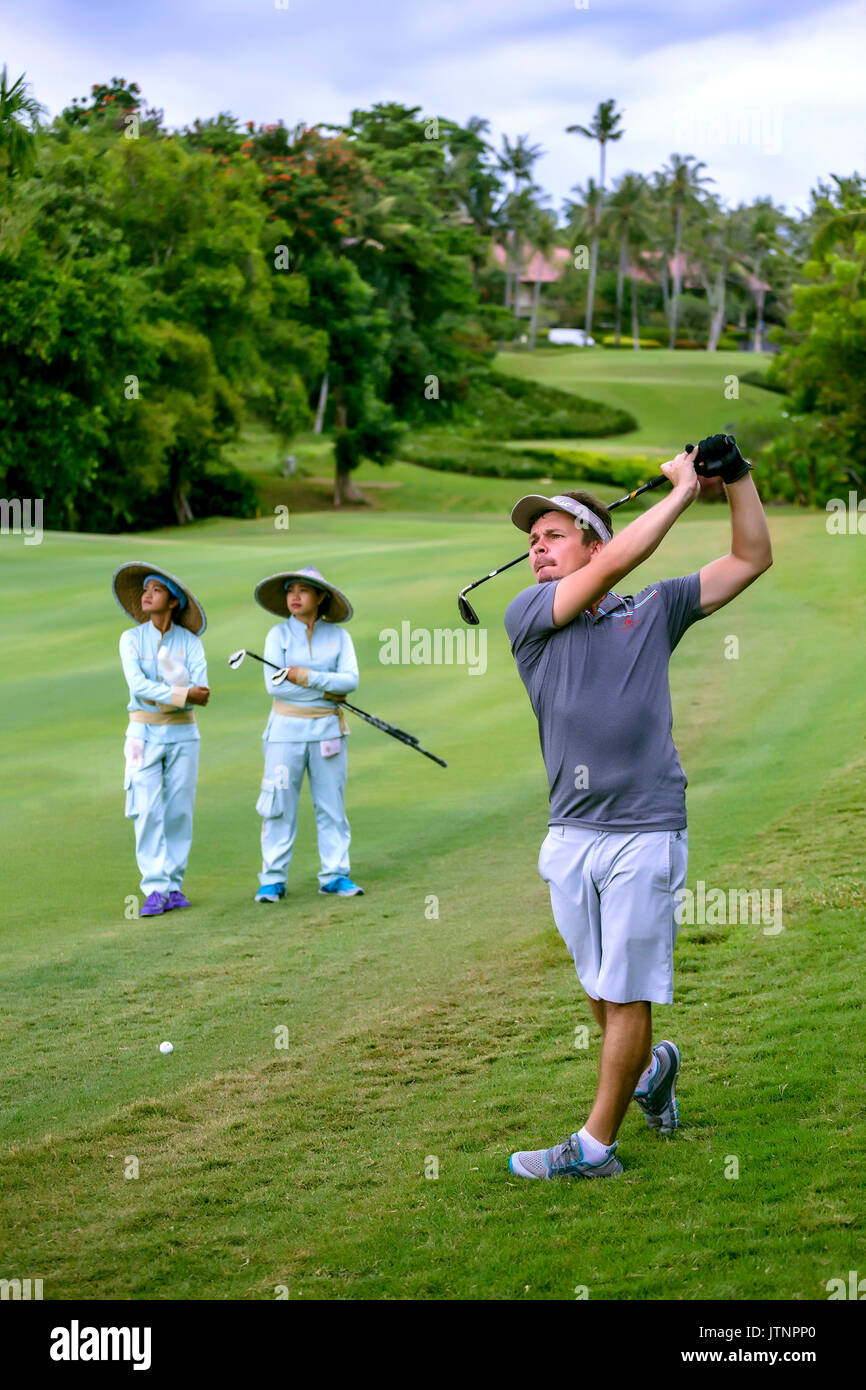 Golf player and caddys, Bali, Indonesia Stock Photo - Alamy