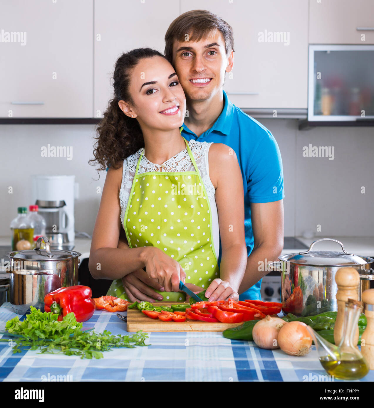 Happy spanish man and woman standing near table with vegetables Stock ...