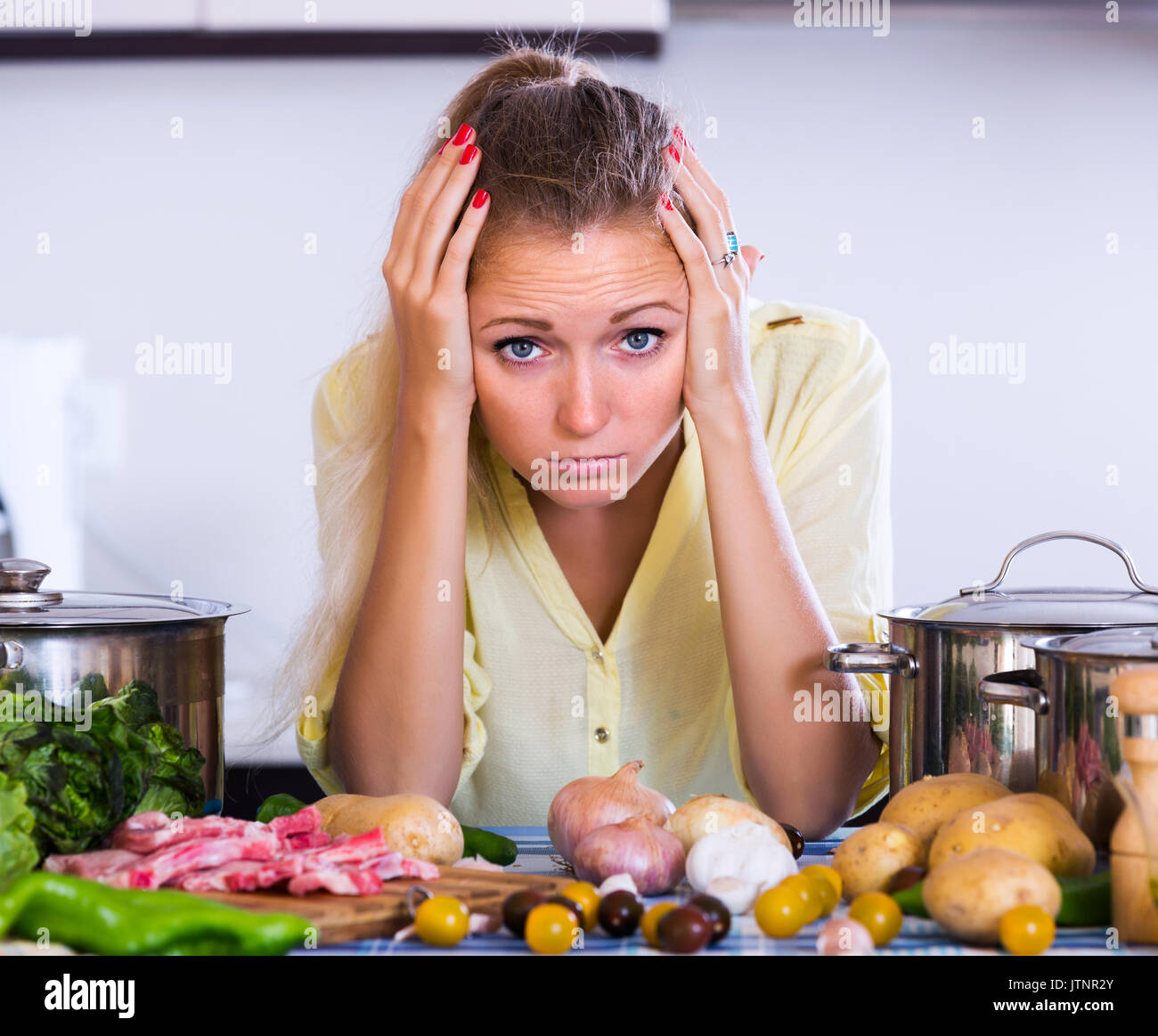 Frustrated woman looking at dinner ingredients with sad face Stock ...