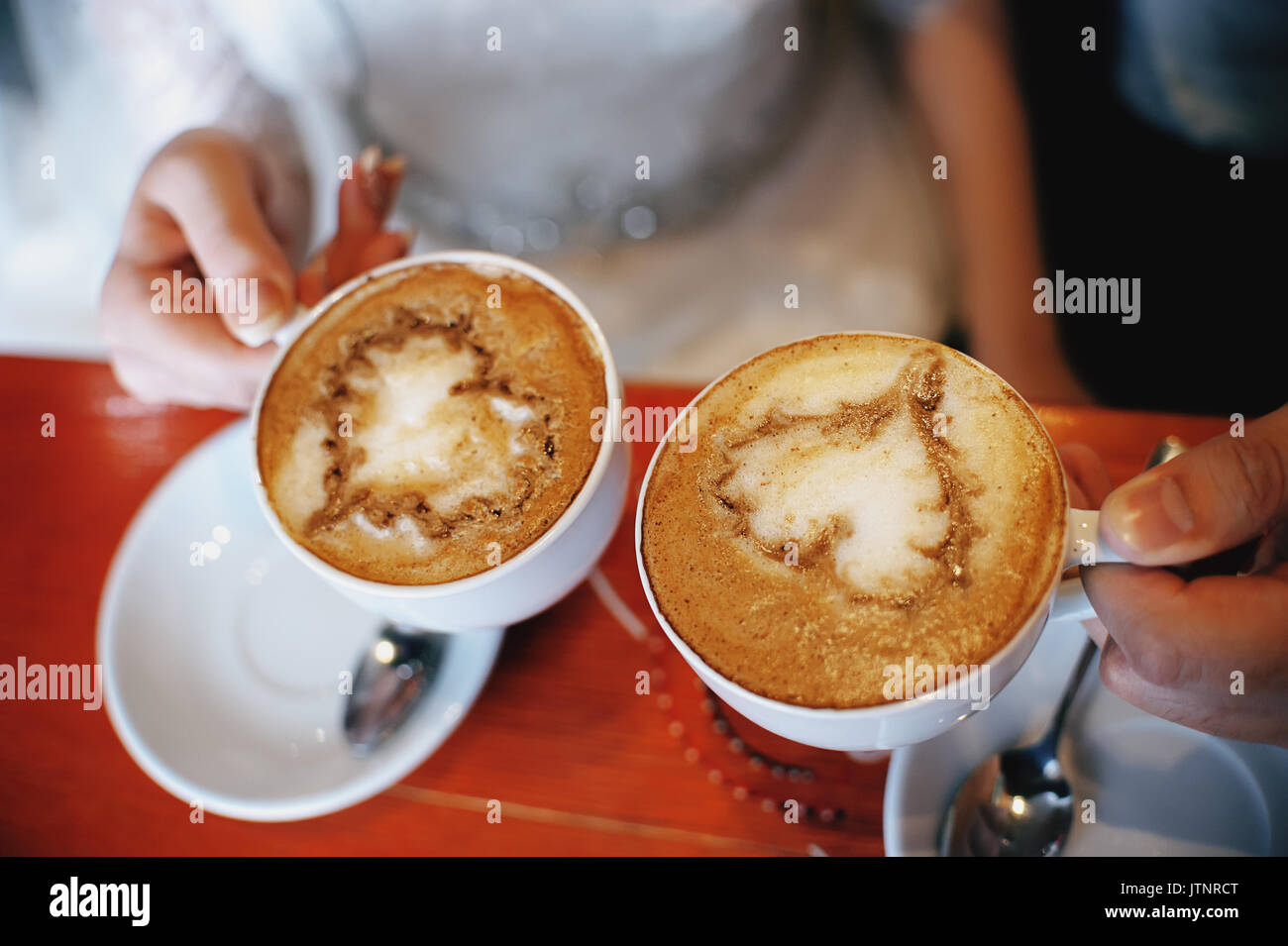 Hot coffee in the hands of a loving couple Stock Photo - Alamy