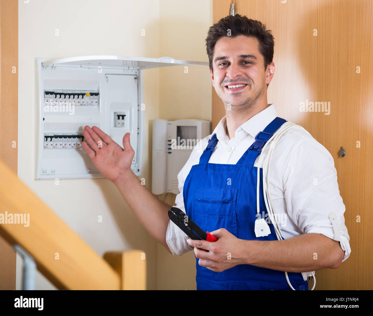 Professional handyman near electric meter in domestic interior Stock ...
