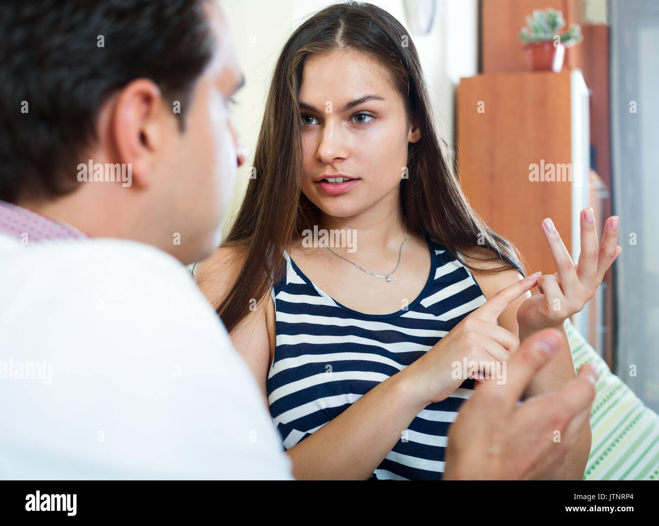 Angry young spouses having domestic argue at living room at the home ...