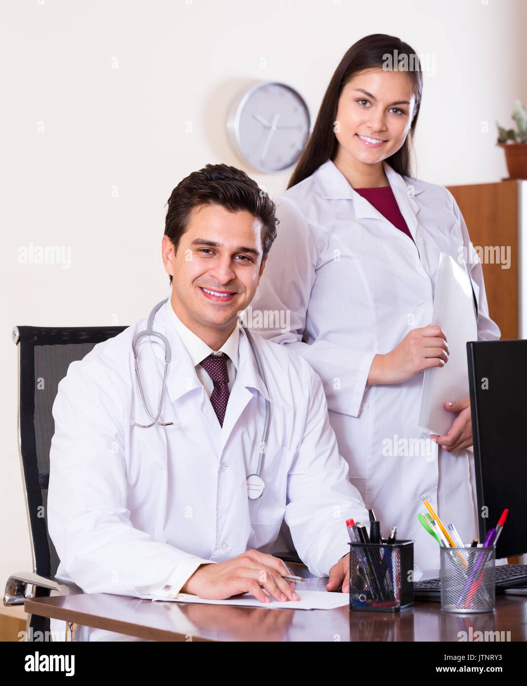 Portrait of two professional doctors smiling in clinic Stock Photo - Alamy