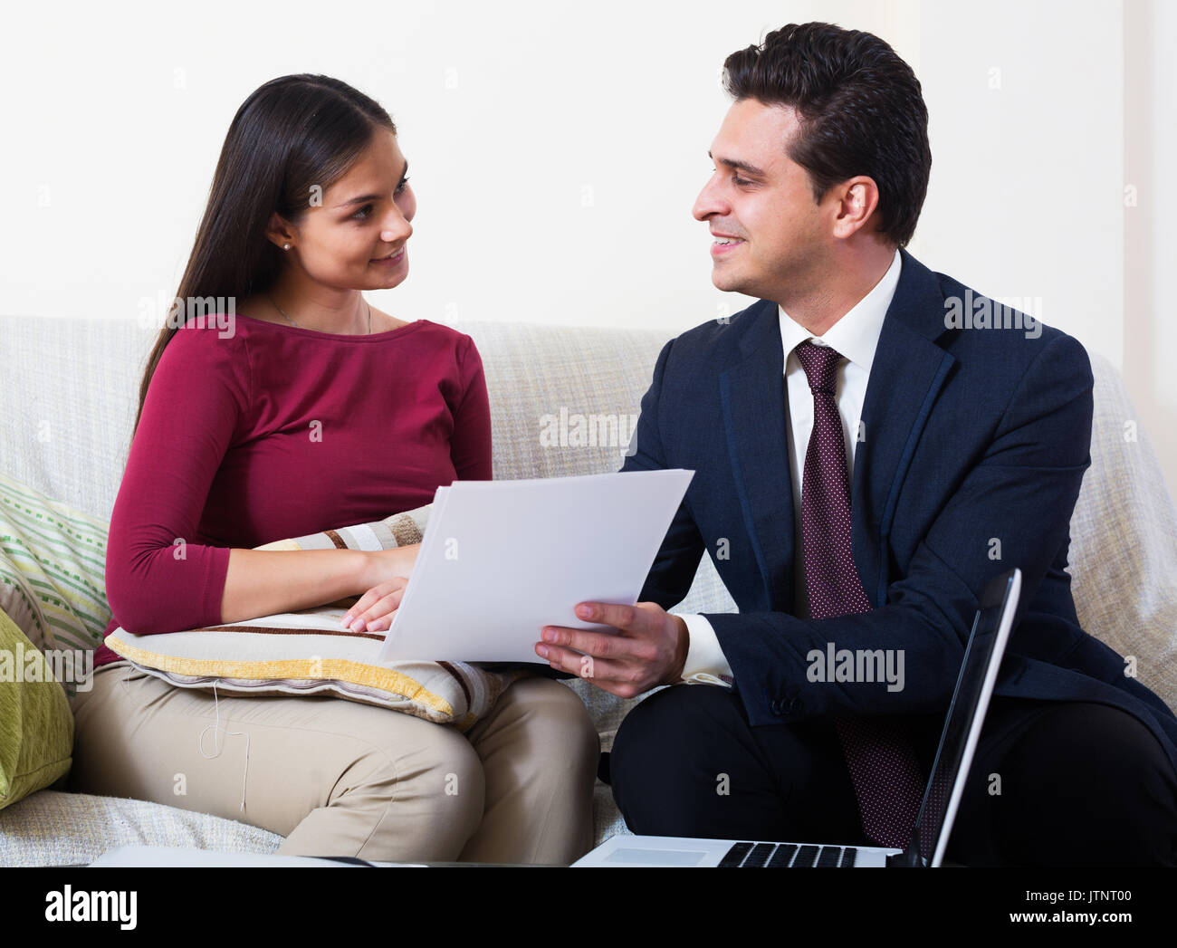 Banking agent showing contract to female client in domestic interior ...