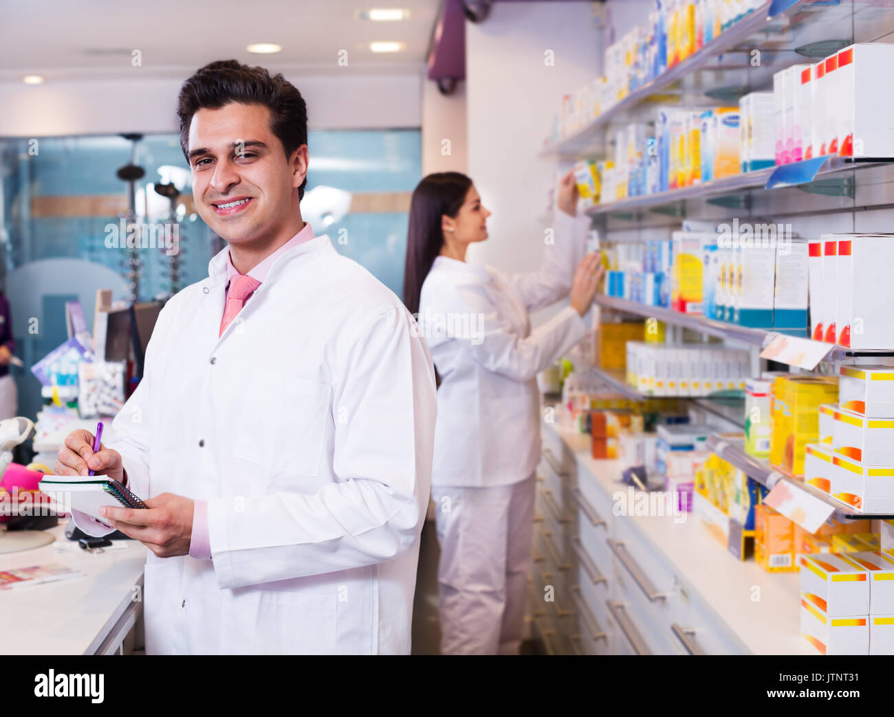 Young team of a pharmaceutist and technician working at a chemist shop ...