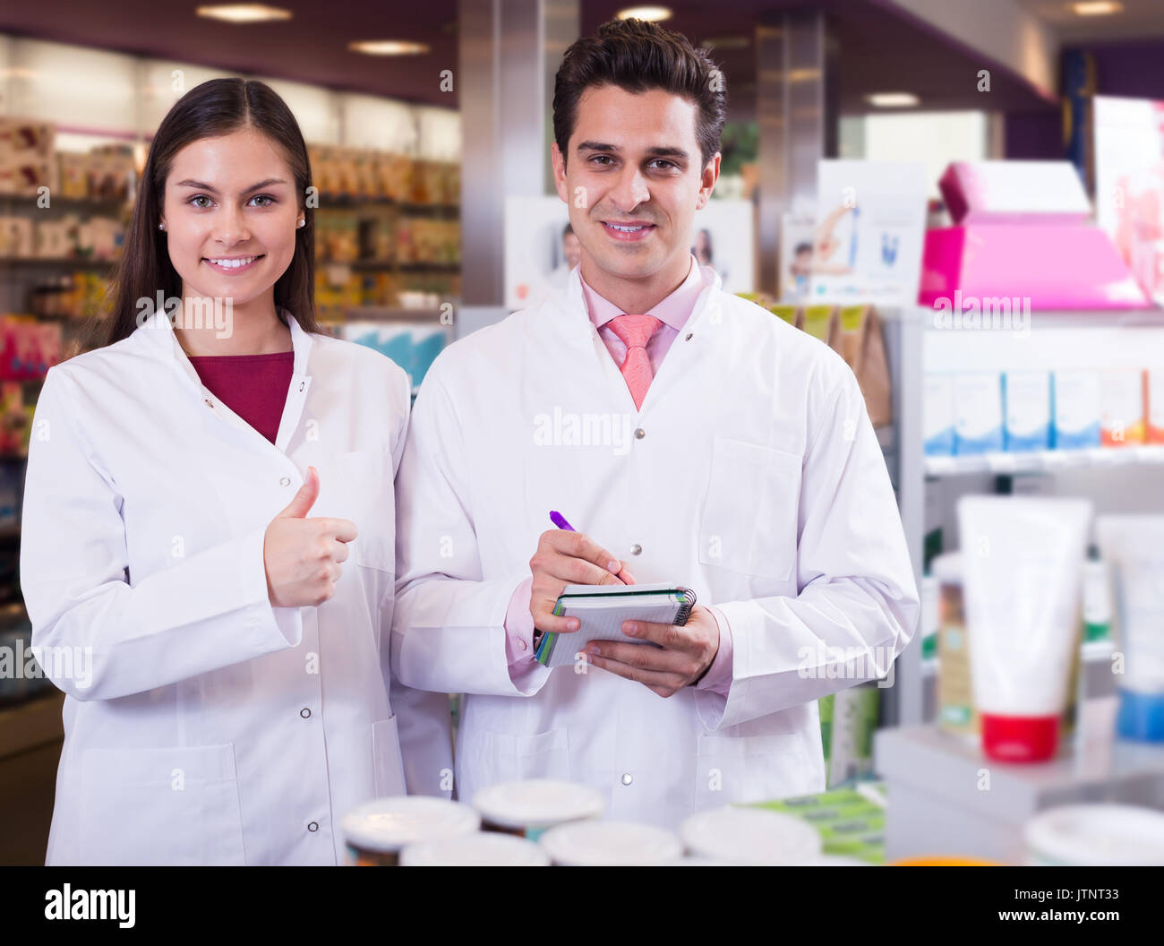 adult team of pharmaceutist and technician working in chemist shop ...