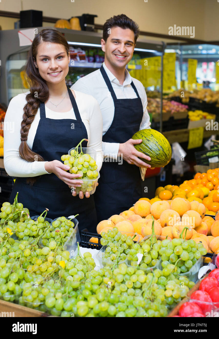 Positive sellers offering good price for fruits in grocery Stock Photo ...