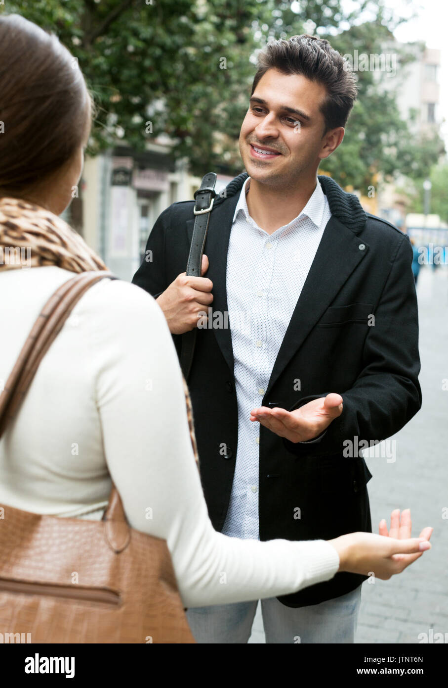 Asian man chasing smiling girl and making offers outdoor Stock Photo ...