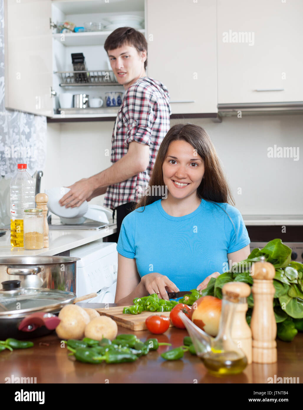 Man and smile woman cooking in domestic kitchen Stock Photo - Alamy