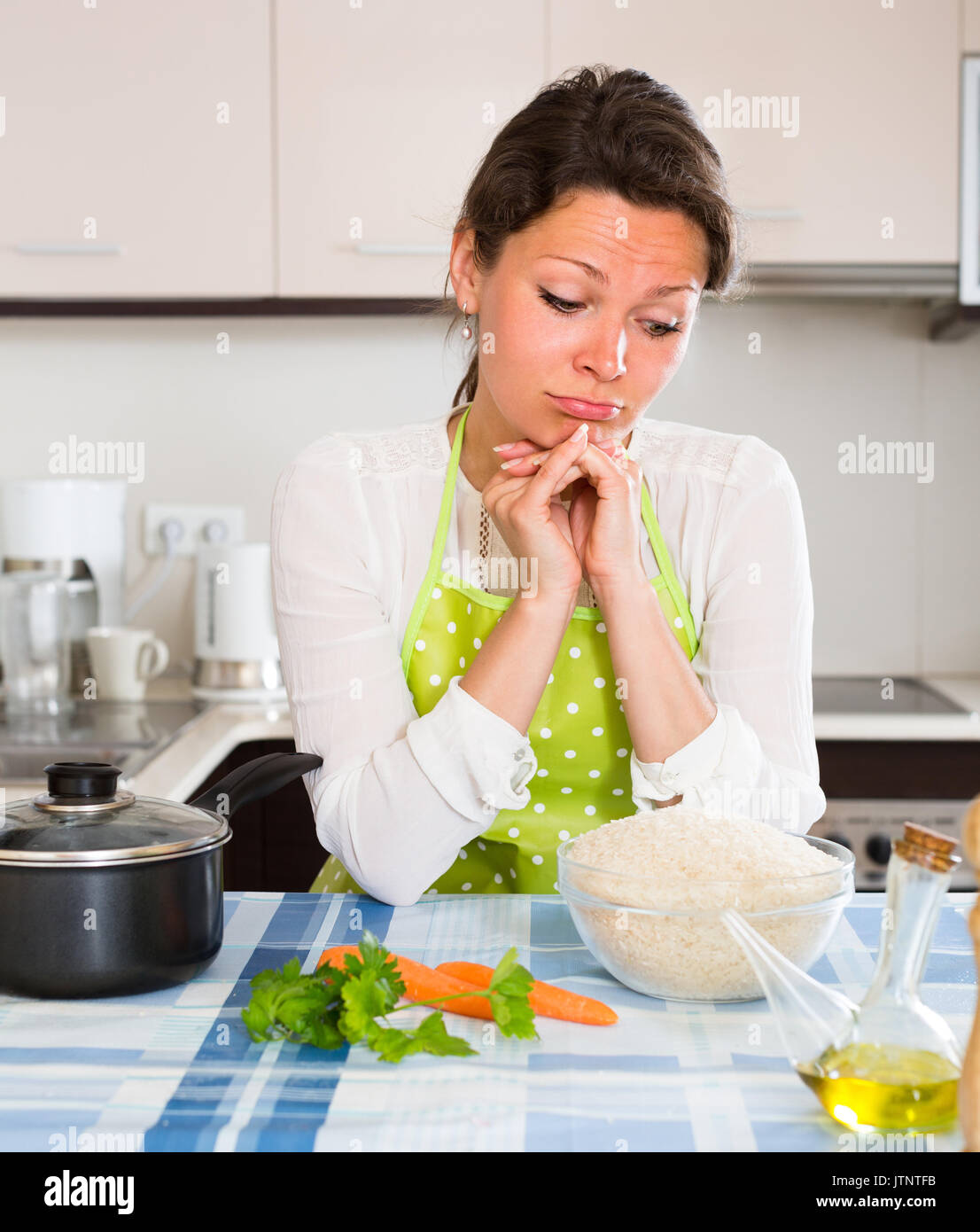 Sad housewife cooking dinner for her family Stock Photo - Alamy