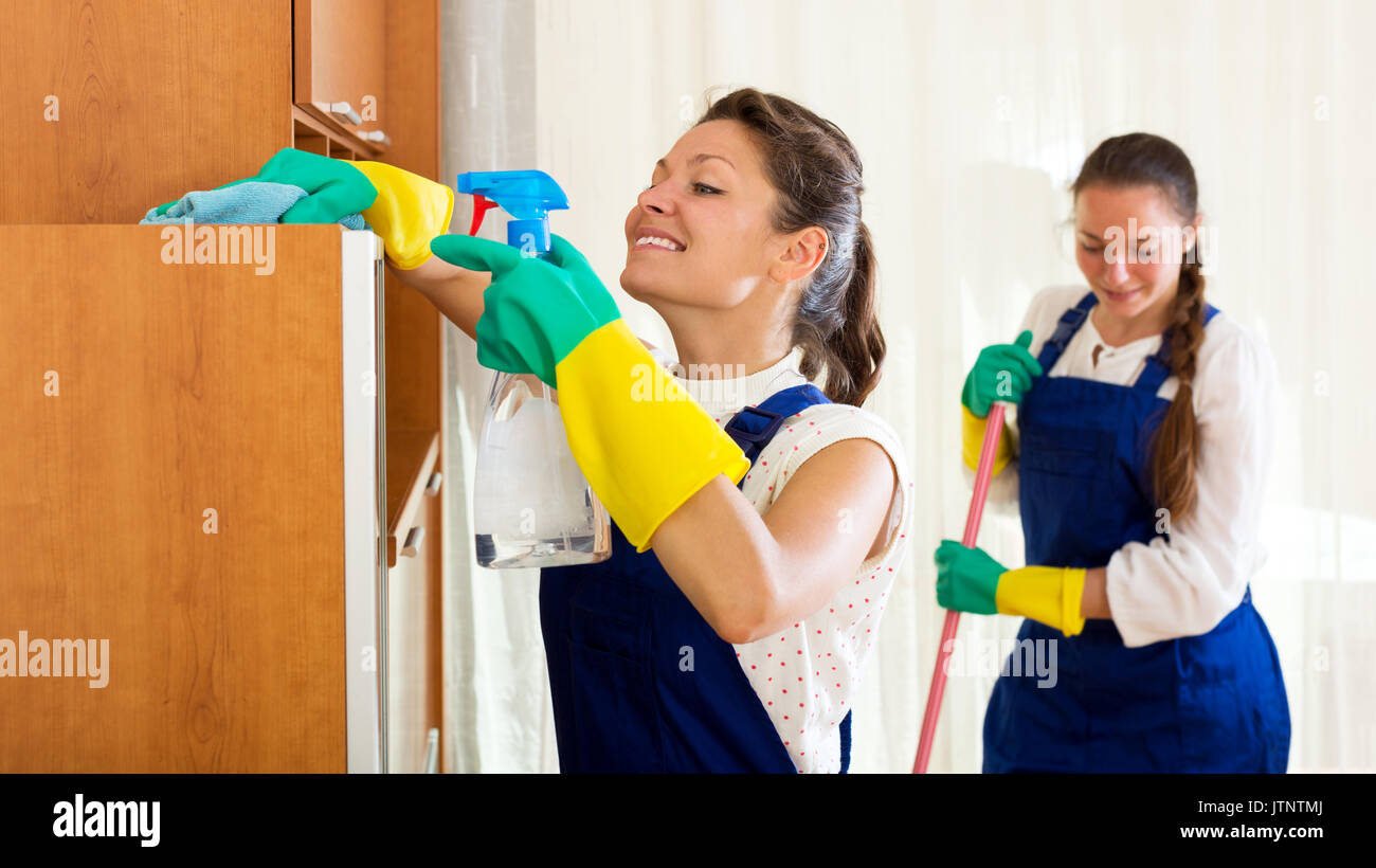 Cheerful young female workers cleaning company ready to start work ...