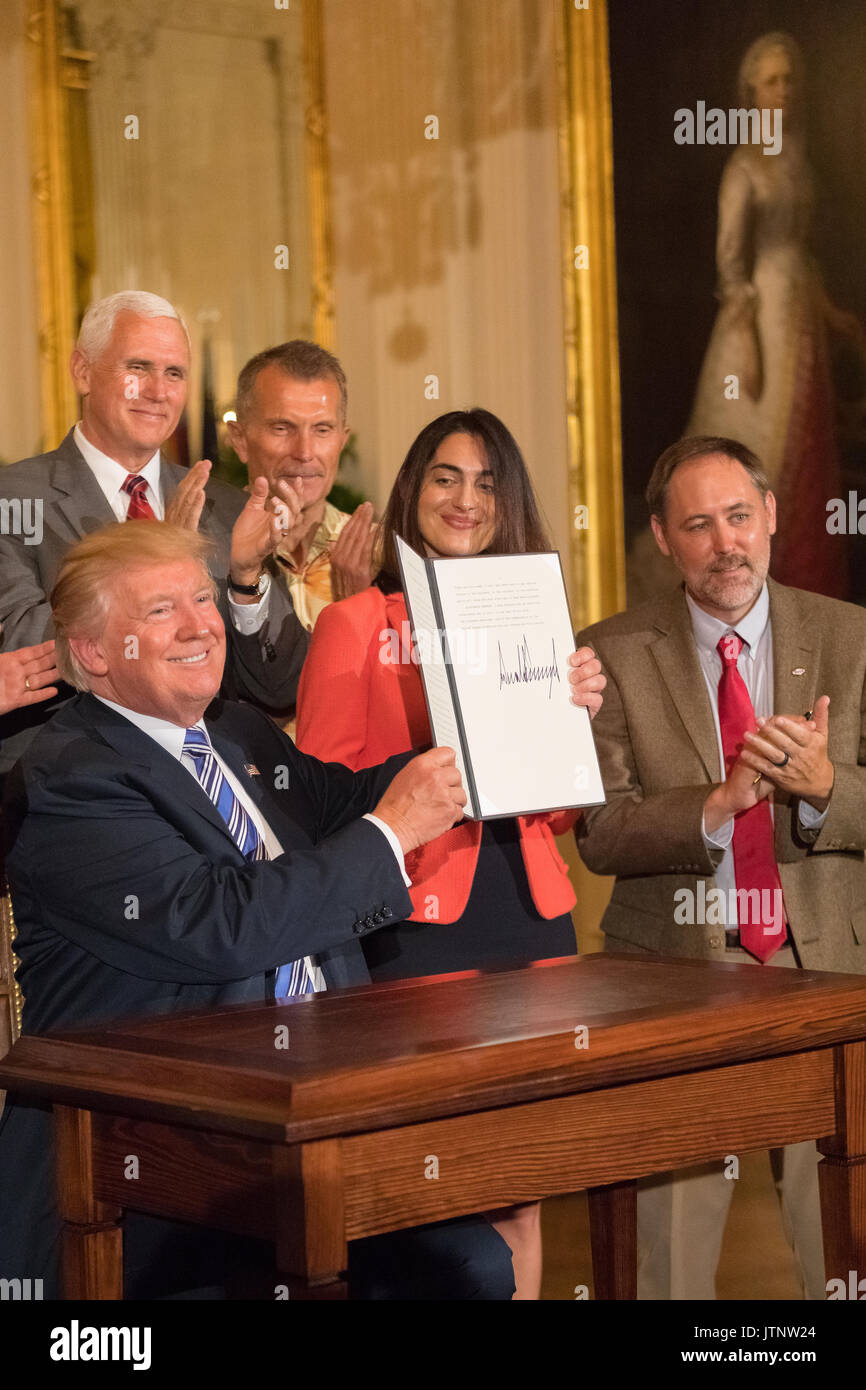 U.S President Donald Trump holds up a proclamation following the ...