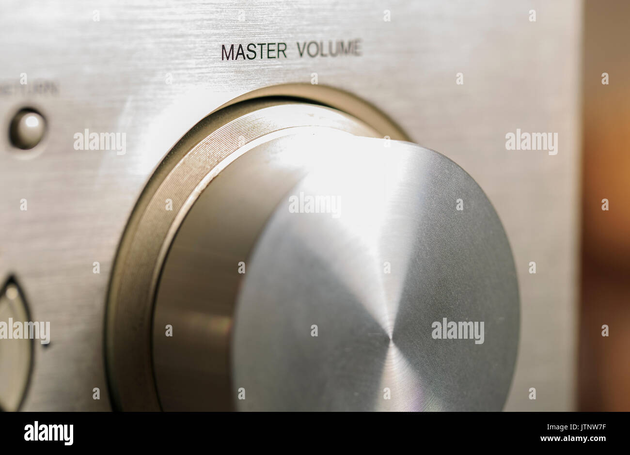 adjusting the volume of the music Stock Photo - Alamy