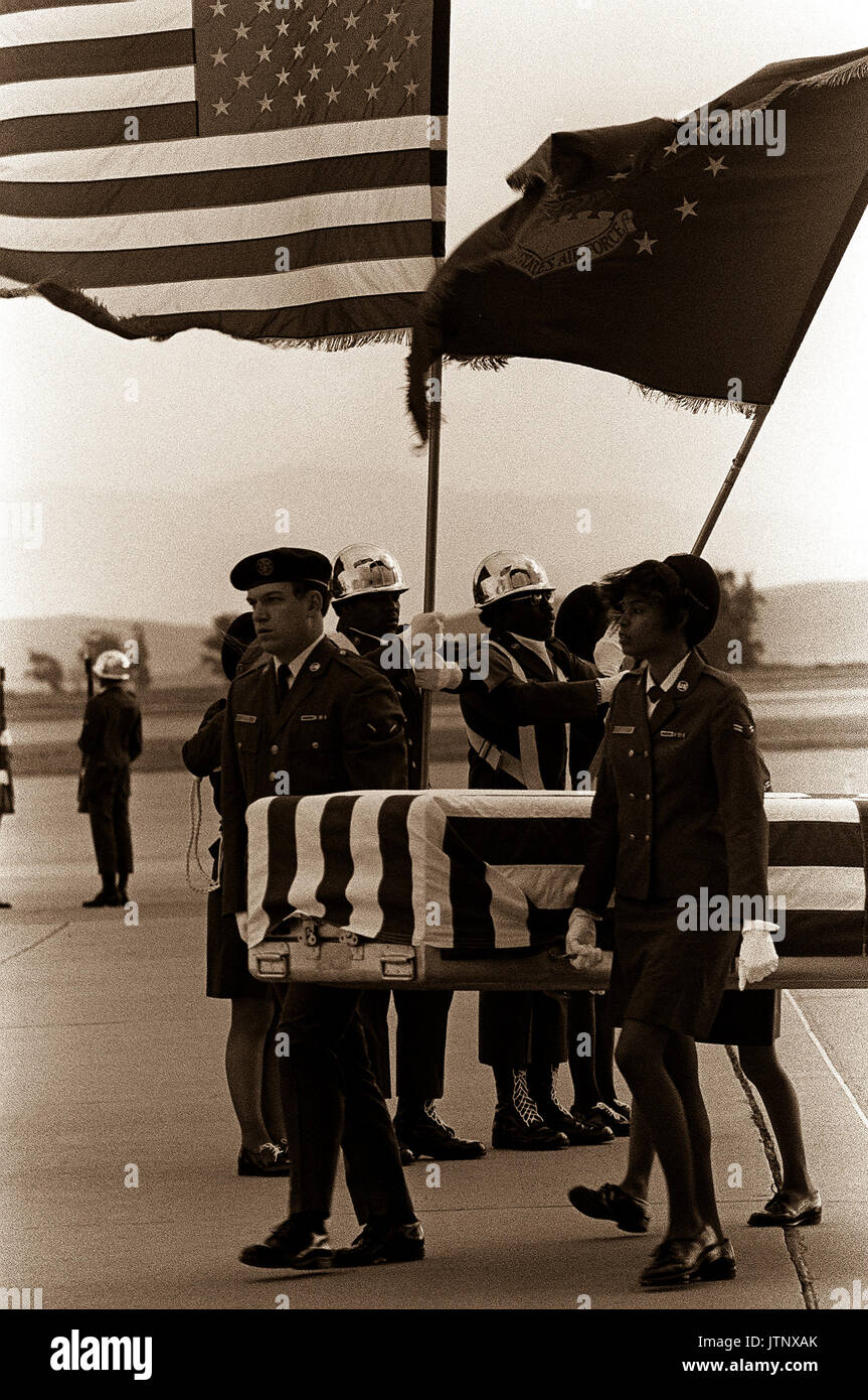 An Air Force Honor Guard Stands At Attention While Pallbearers Carry