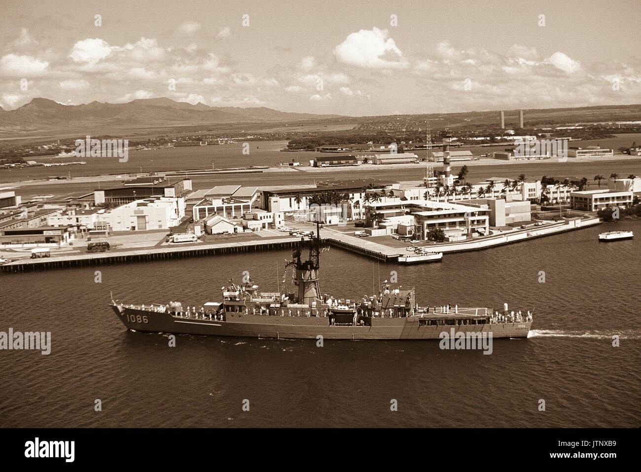 An aerial port beam view of the frigate USS BREWTON (FF 1086) leaving ...