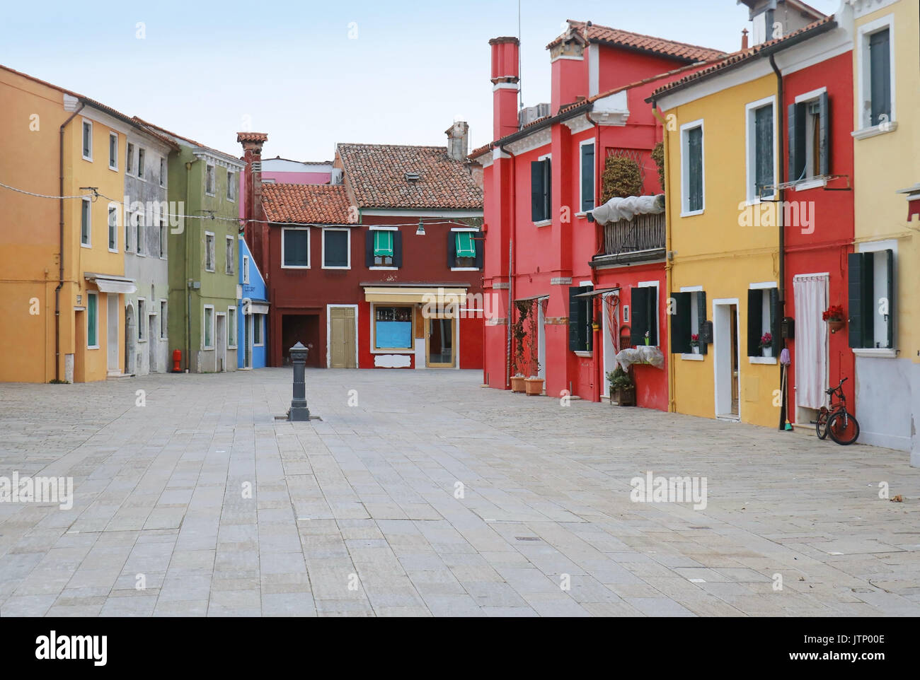 Small empty square with colorful facade houses Stock Photo - Alamy