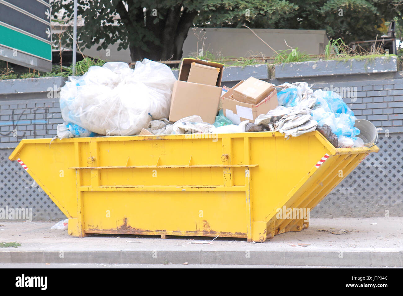 Large recycled material pile inside yellow container Stock Photo - Alamy