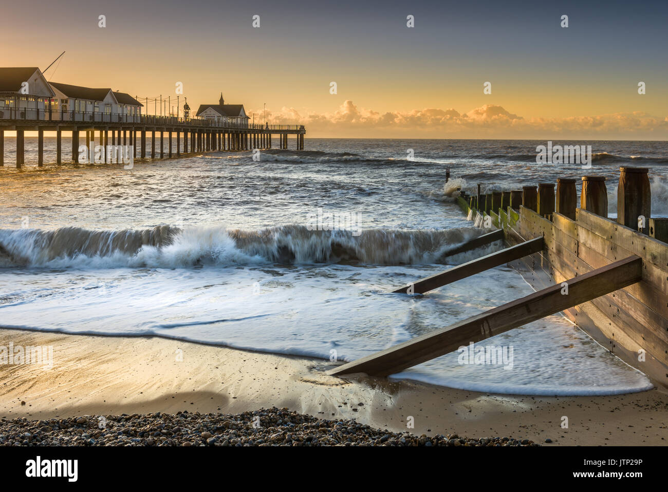 The sun rises behind the Pier in the popular Suffolk seaside town of ...