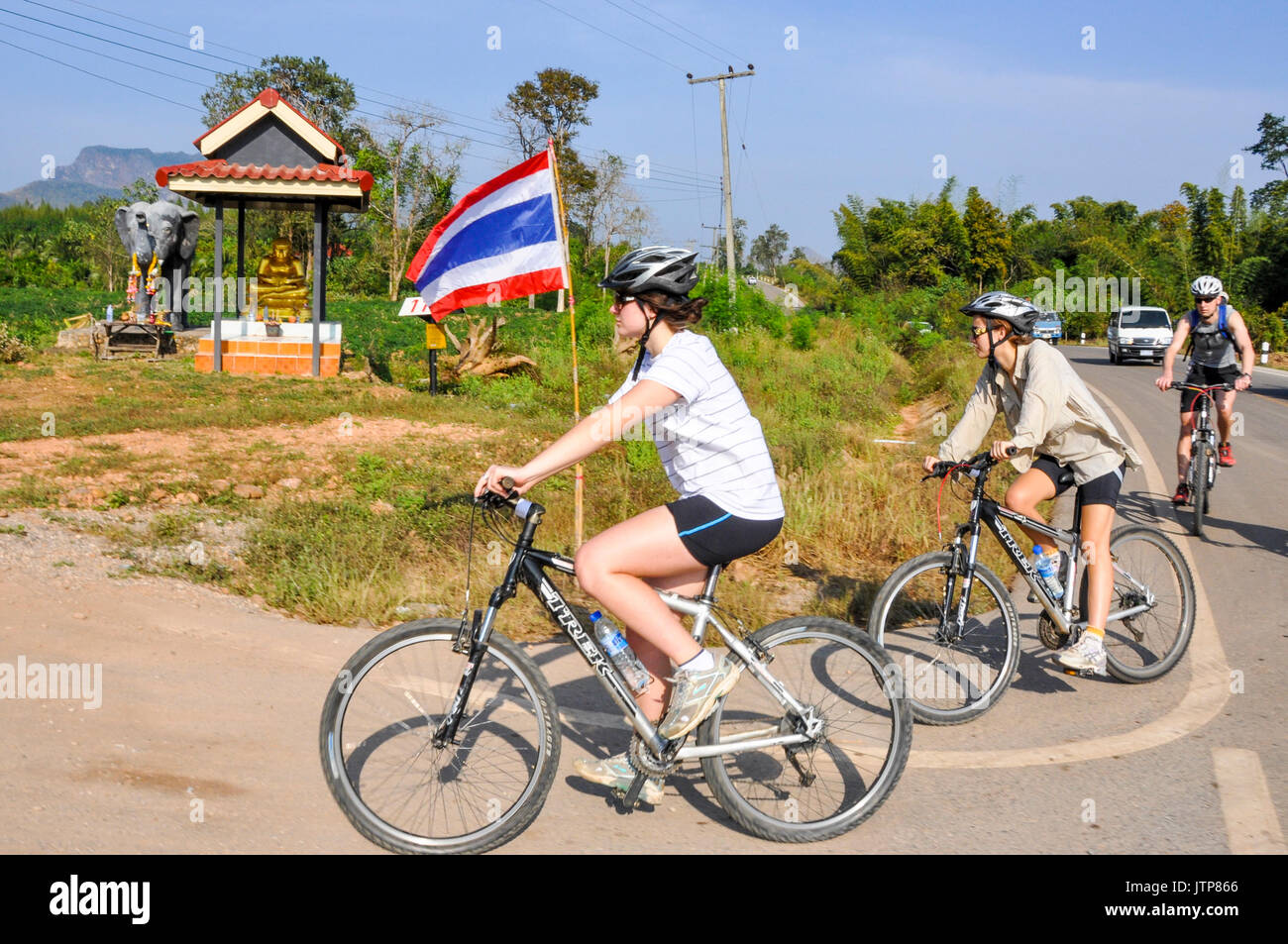 Touring cyclists cycling on a country road in the countryside of ...