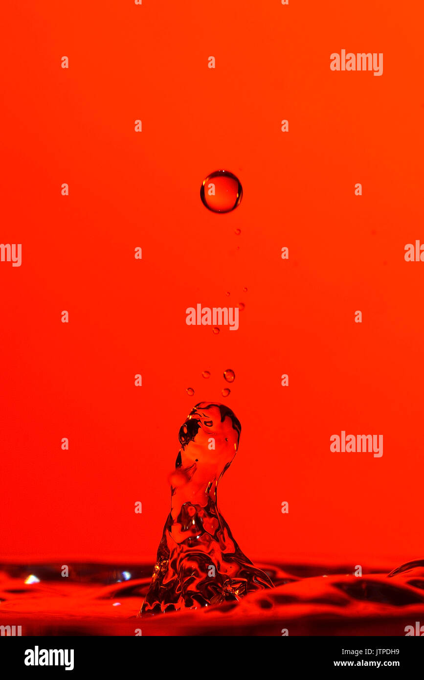 High-speed photograph of a water drop impacting on water showing ...