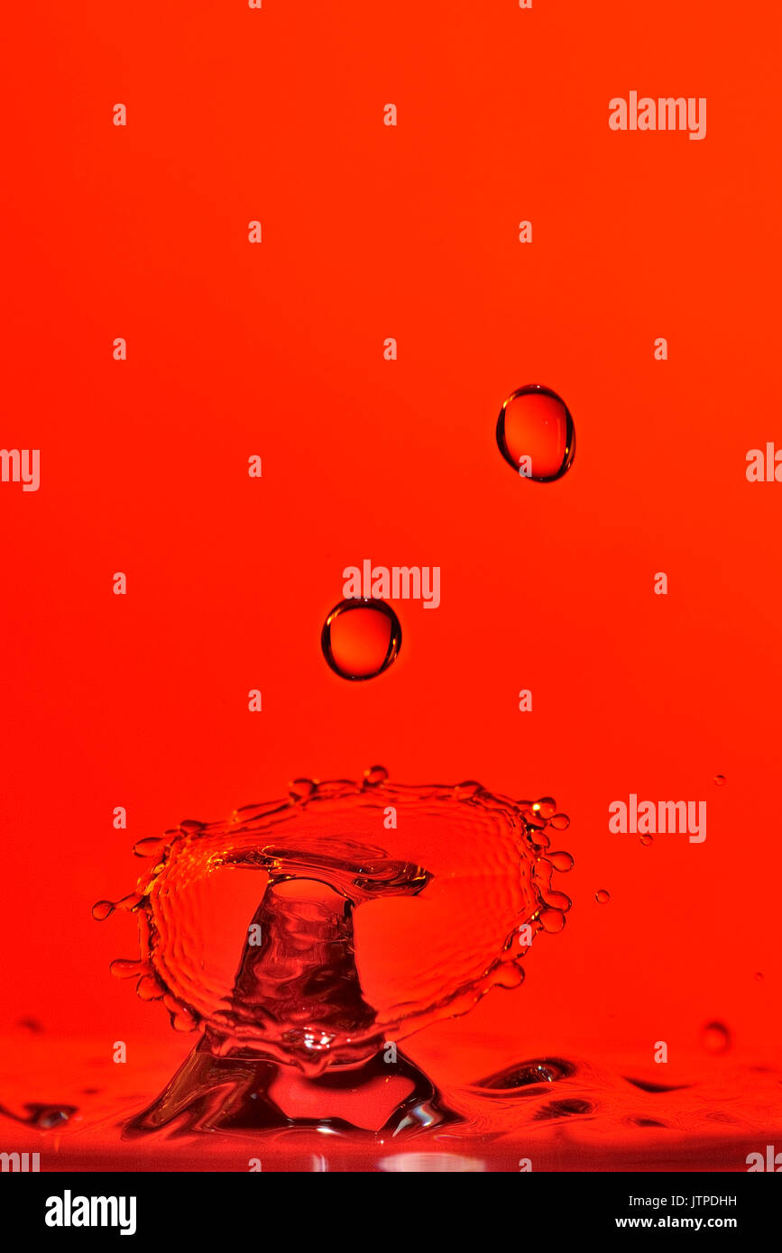 High-speed photograph of a water drop impacting on water showing ...