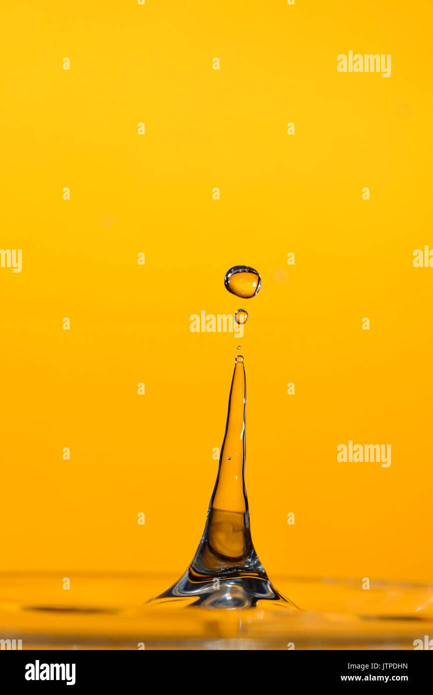 High-speed photograph of a water drop impacting on water showing ...