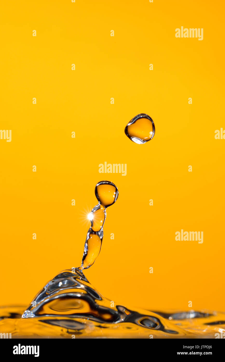 High-speed photograph of a water drop impacting on water showing ...