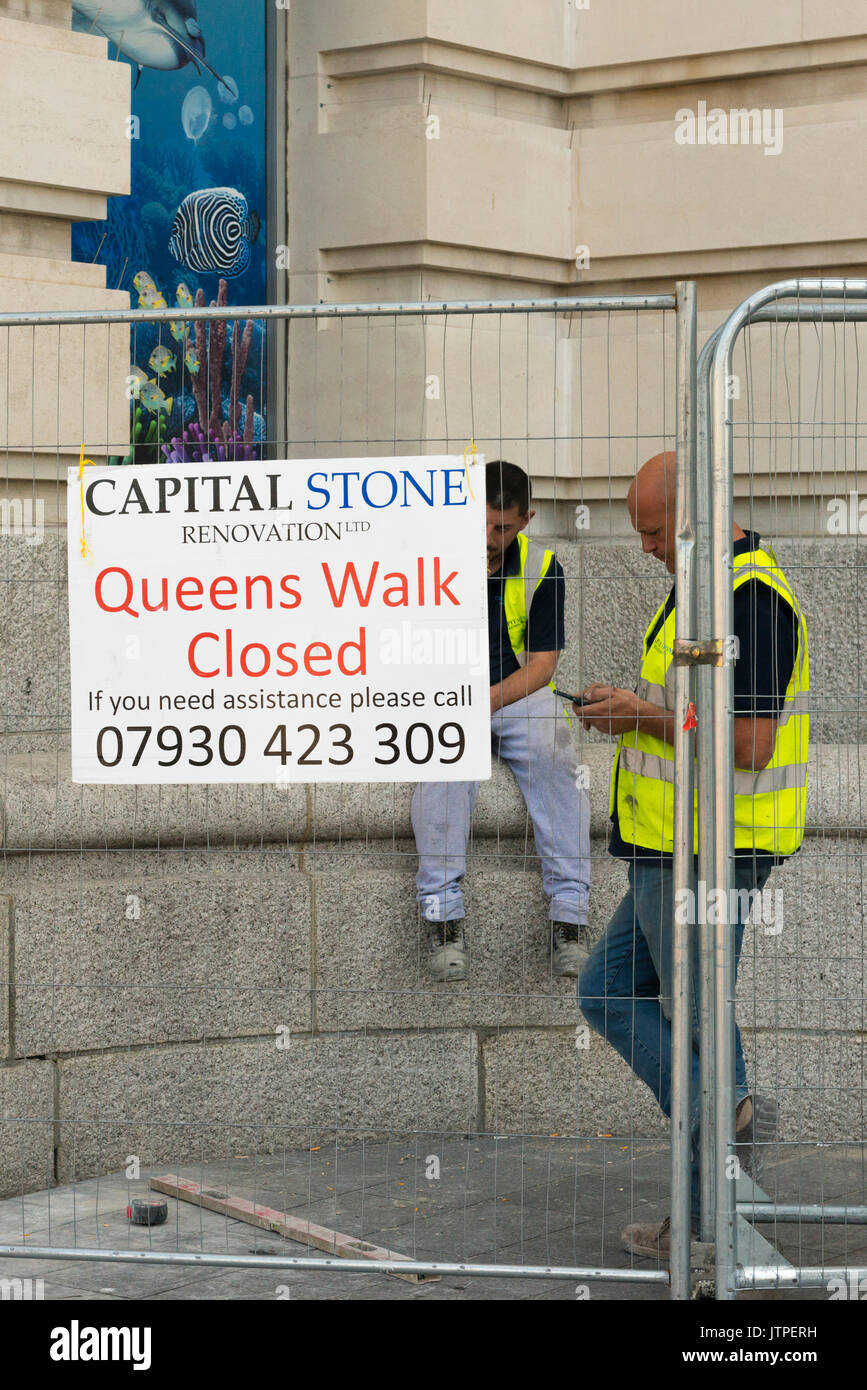 UK London Southbank Queens Walk British workmen hard at work playing ...