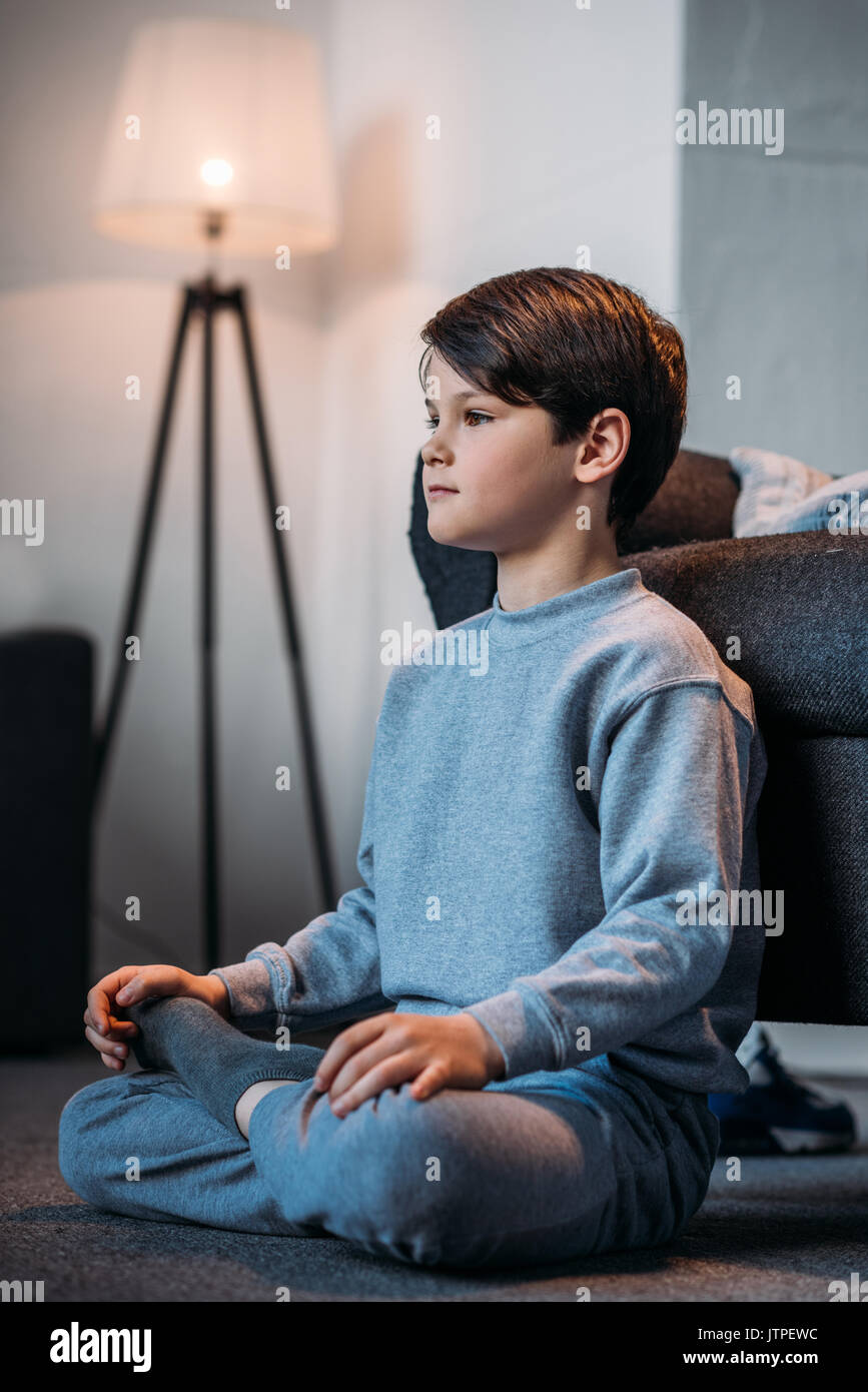 portrait of adorable boy sitting in lotus pose at home Stock Photo - Alamy