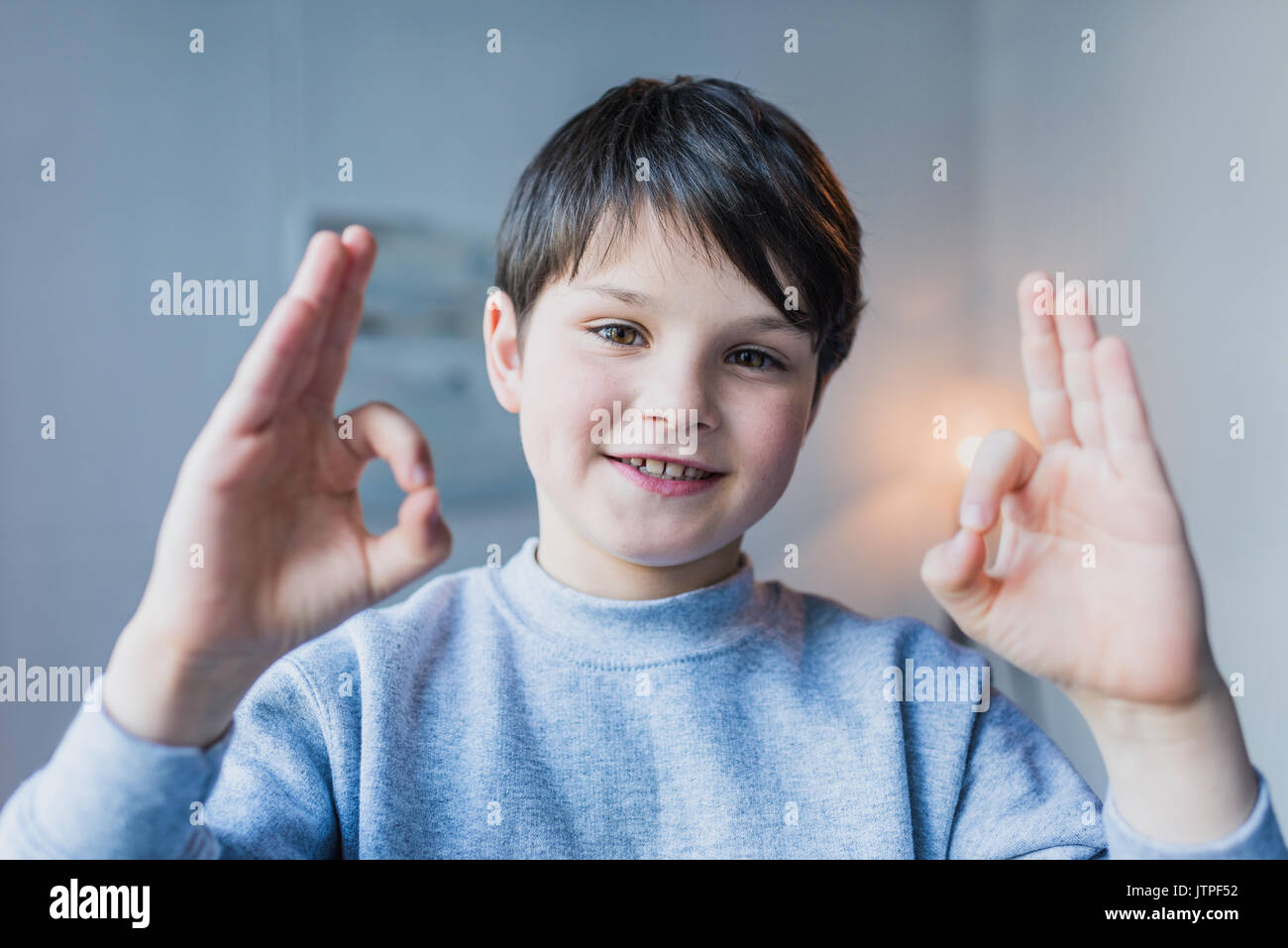 Cute little boy showing ok sign and smiling at camera Stock Photo - Alamy