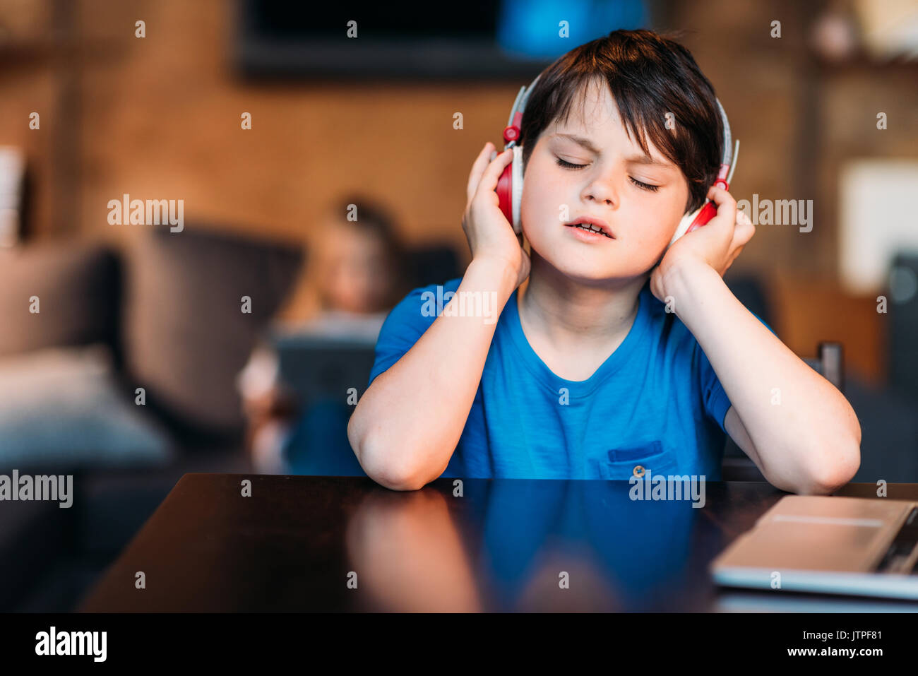 portrait of concentrated little boy listening music in headphones Stock ...