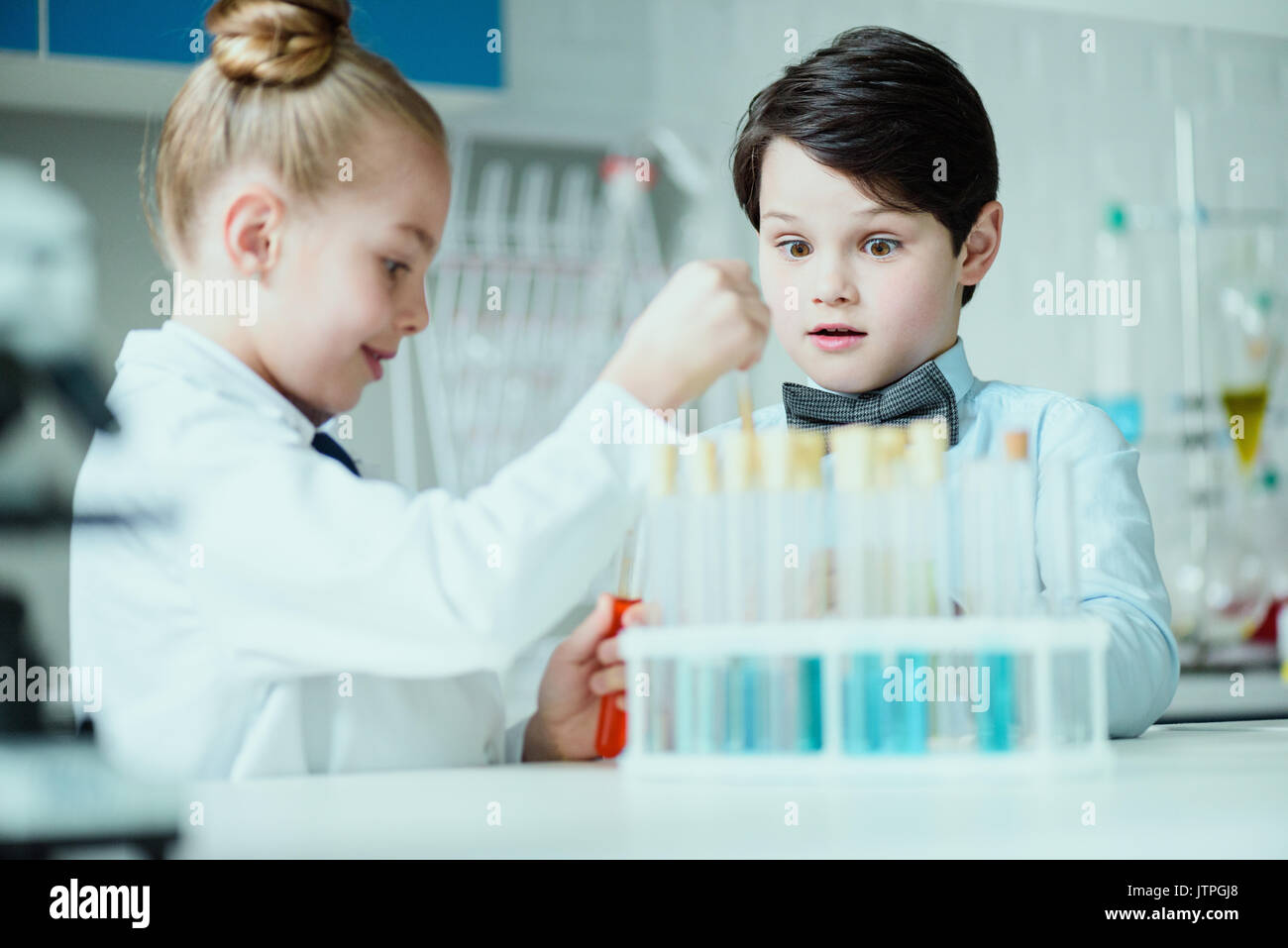 schoolchildren with science lab equipment in chemical lab, science ...