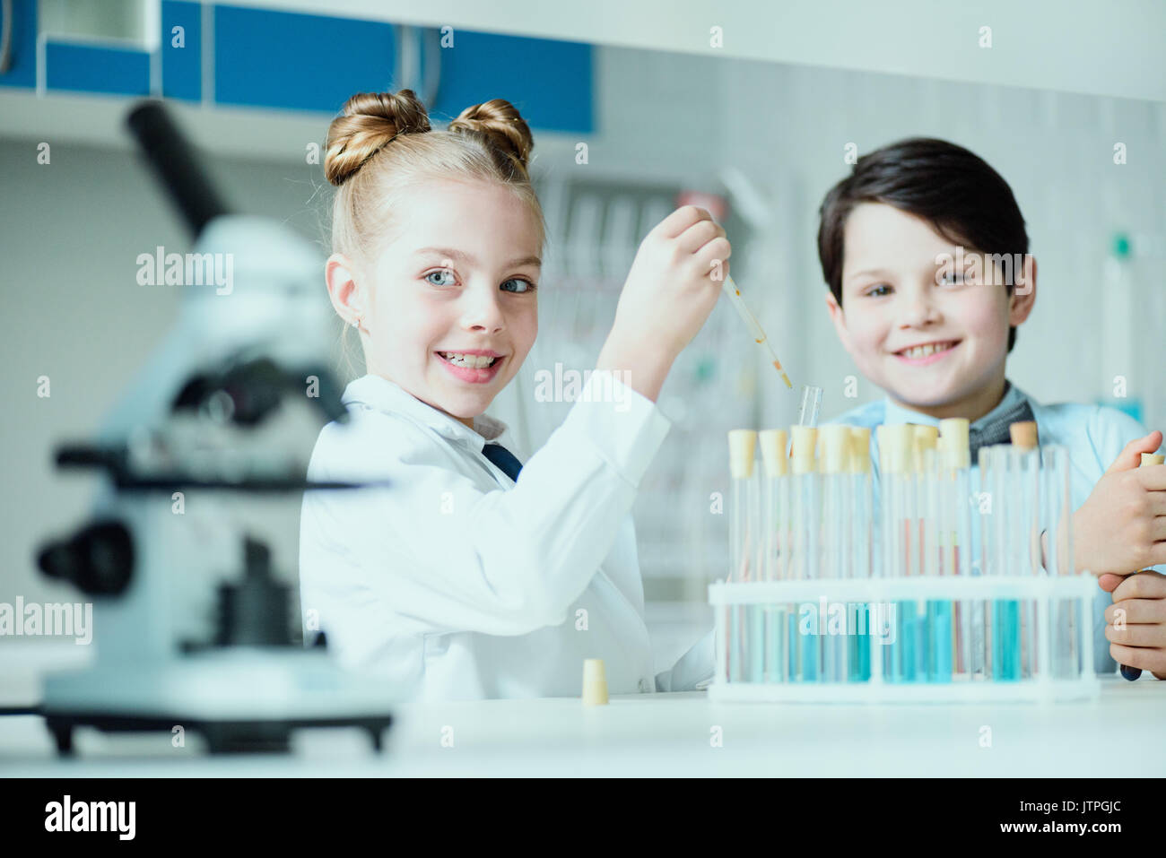 schoolchildren with science lab equipment in chemical lab, scientists ...