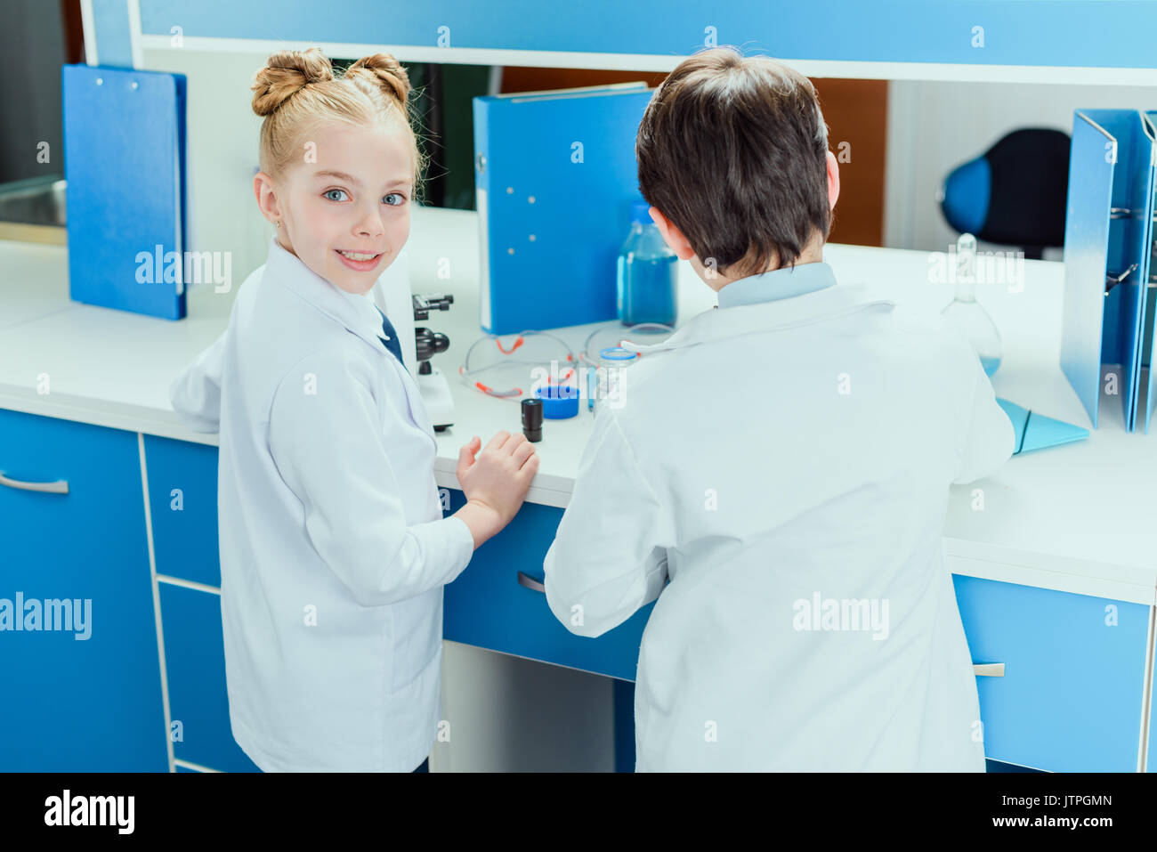 schoolchildren with science lab equipment in chemical lab, scientists ...