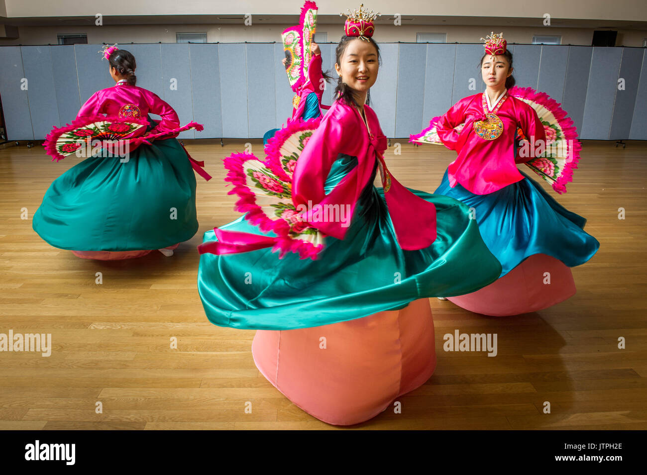 Korean female dancers gleefully twirl during fan dance Stock Photo - Alamy