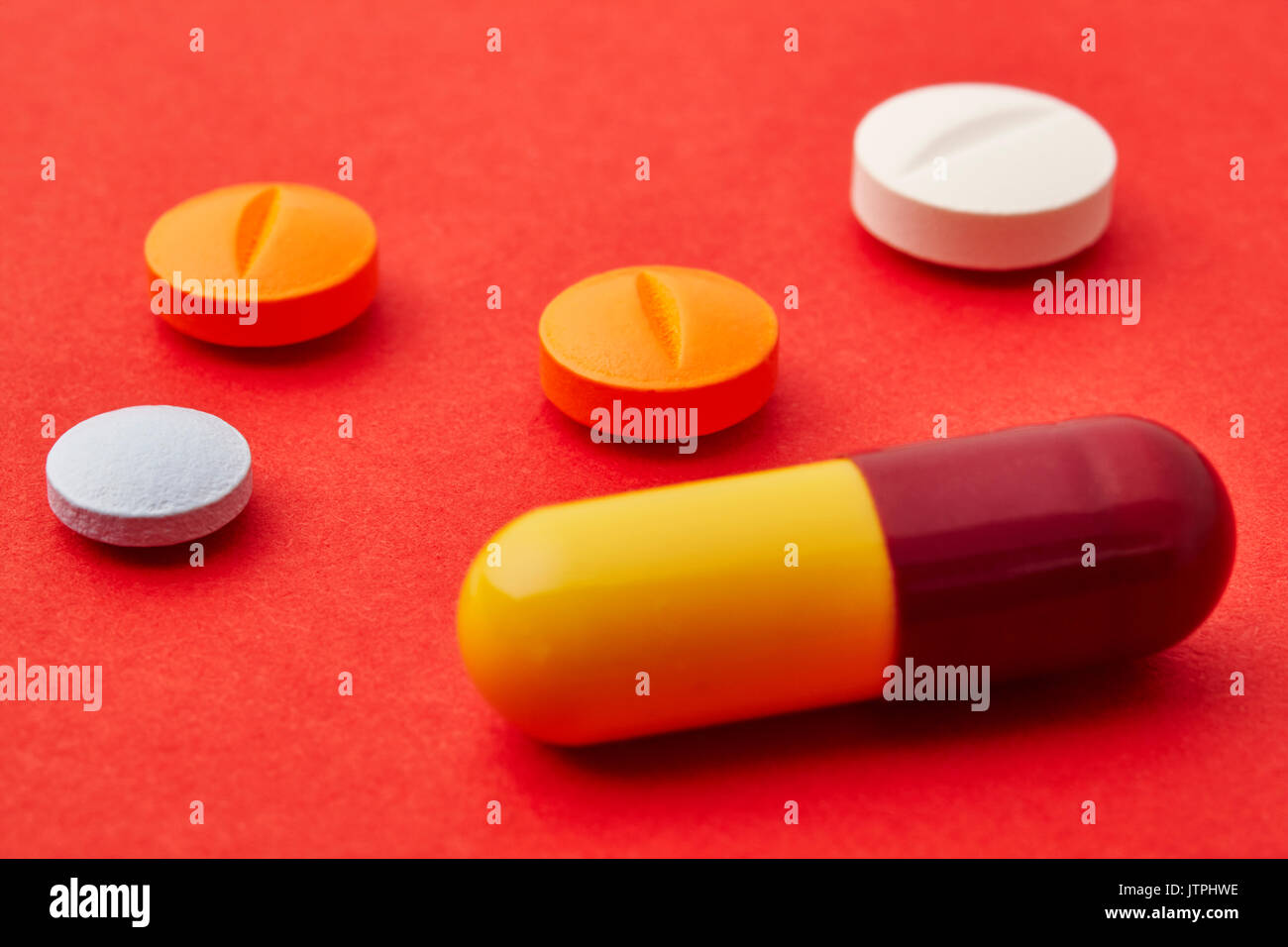 Pills over a red background. Medicament treatment. Health care photo ...
