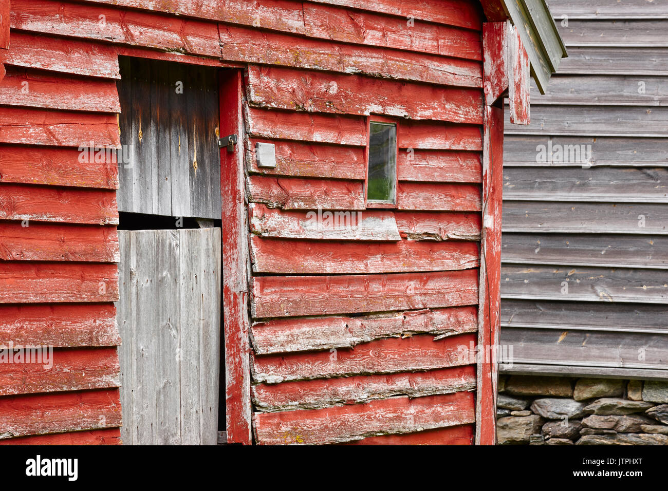 Traditional norwegian wooden red colored cabin houses facades. Otternes ...