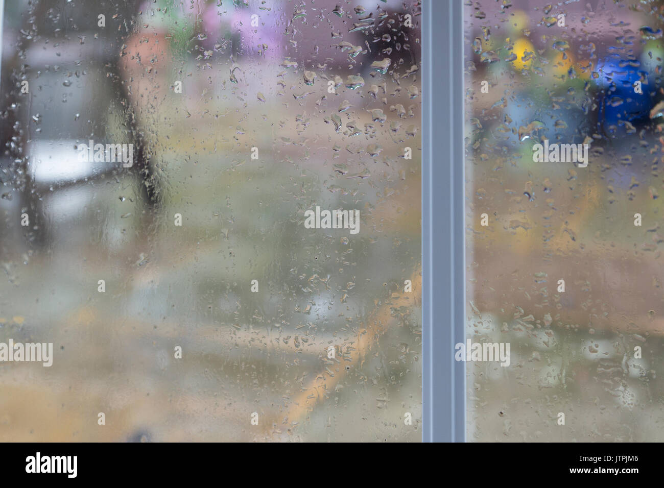 Raindrops Running Down a Window with a View Outside onto a Patio Stock ...