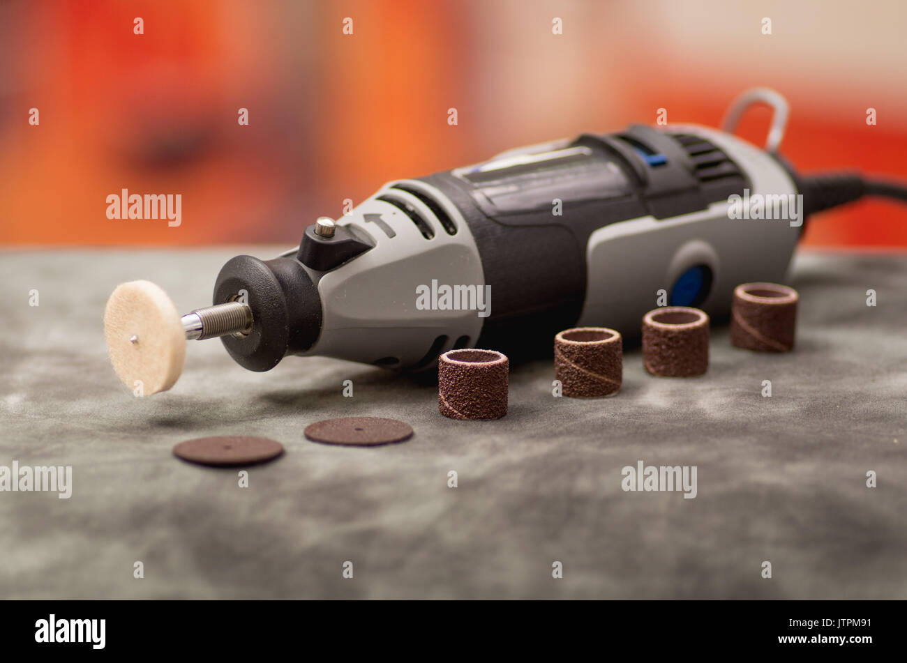 A gray drill with drilling accessories on gray background Stock Photo ...