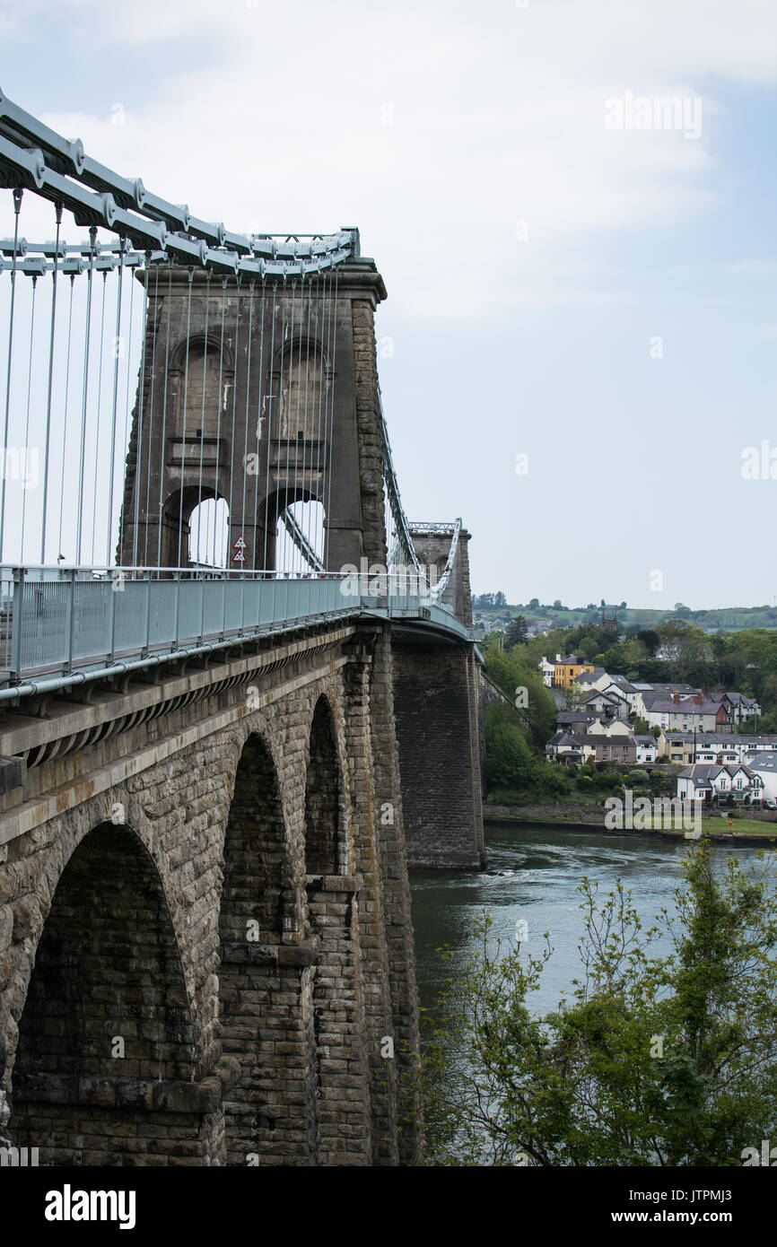 a side view of the menai bridge with the menai straits running ...