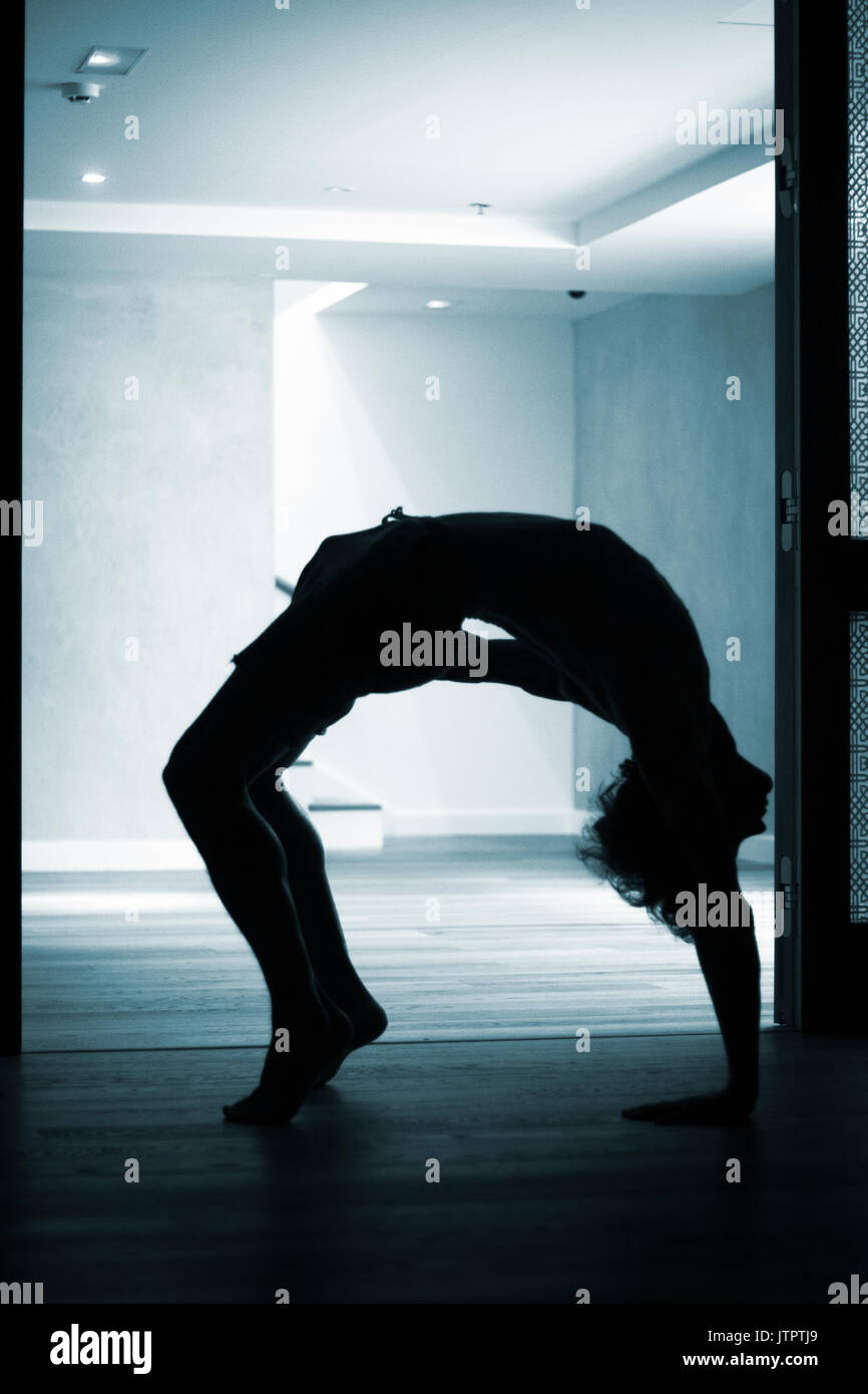 Yoga teacher doing backbend bridge flexibility and strength asana ...