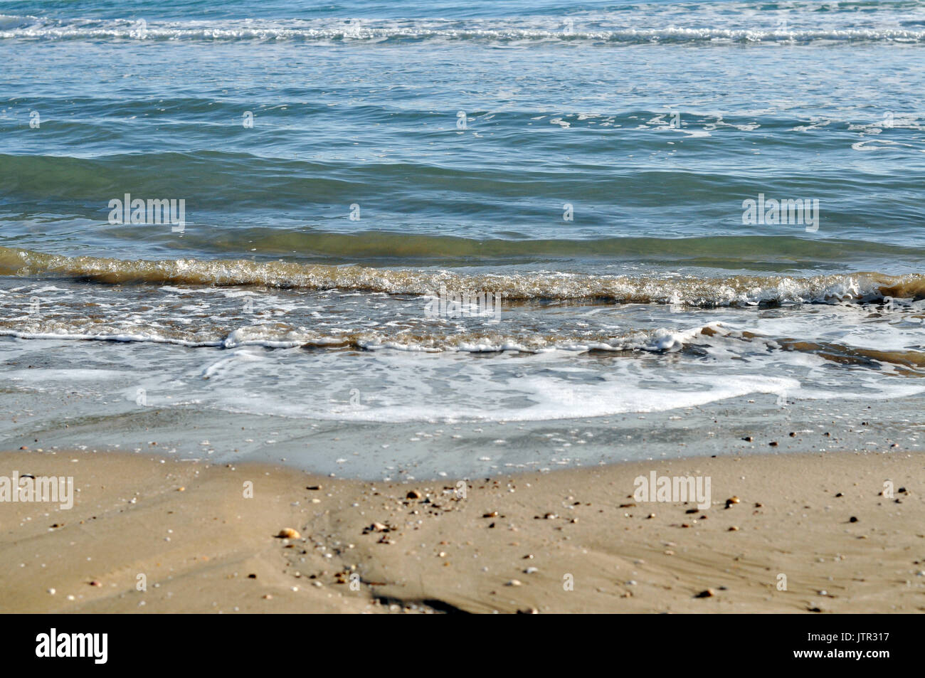Sea water waves approaching to the beach Stock Photo - Alamy