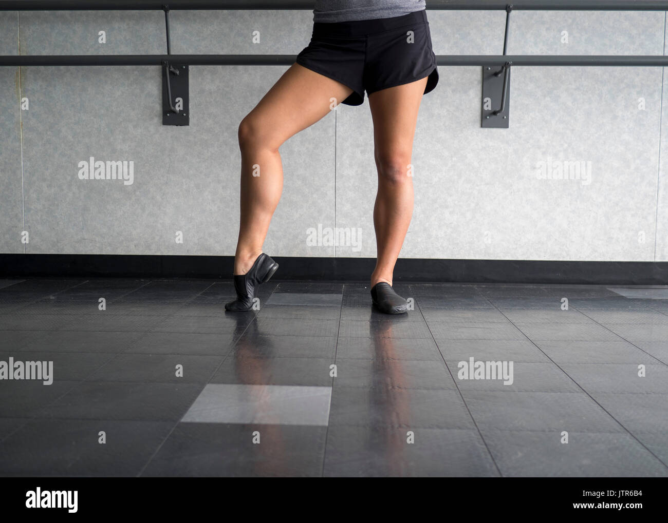 Jazz dancer pose with foot in dig Stock Photo - Alamy